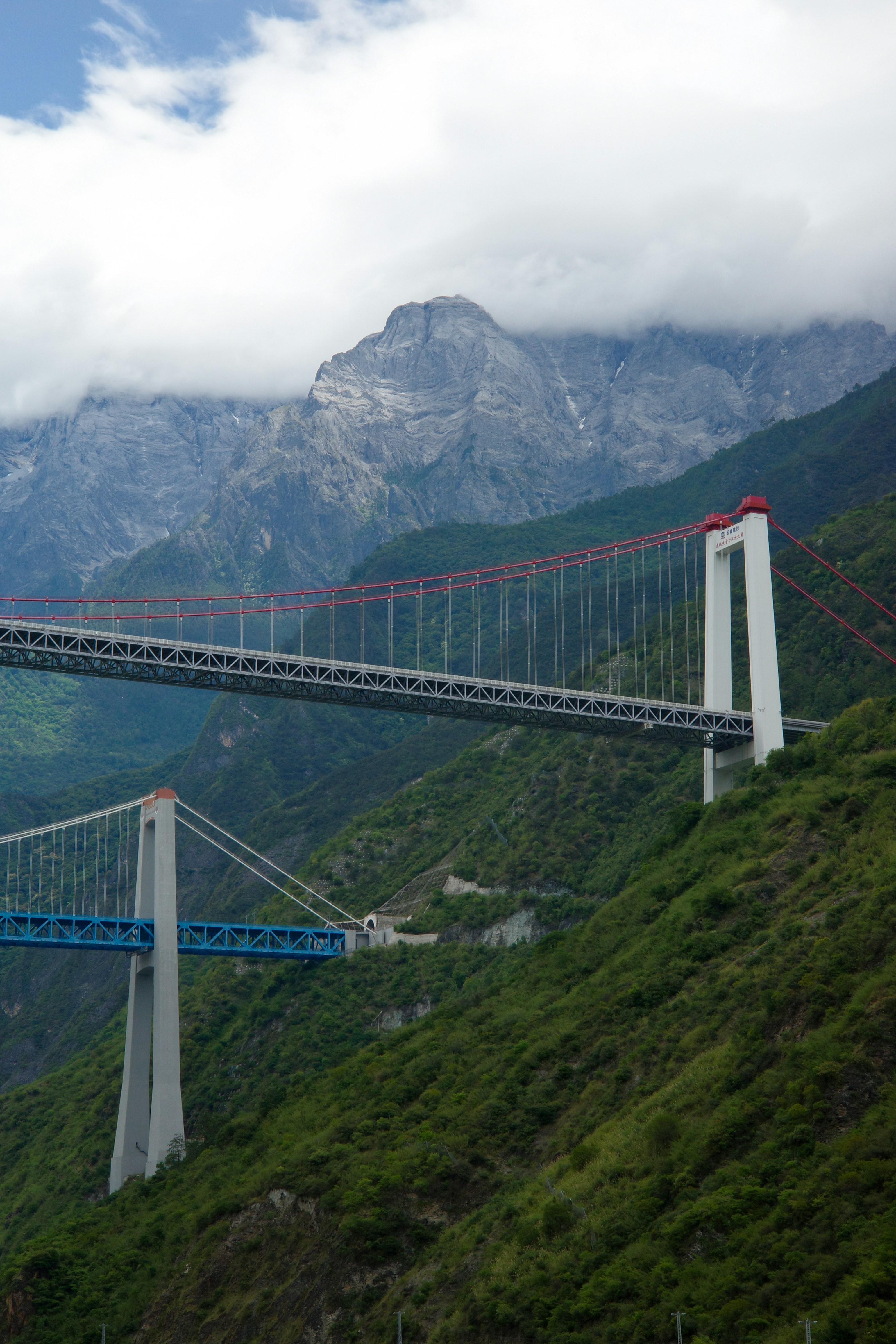 Suspended Giants: A Cable-Streak Across Mountain Veil