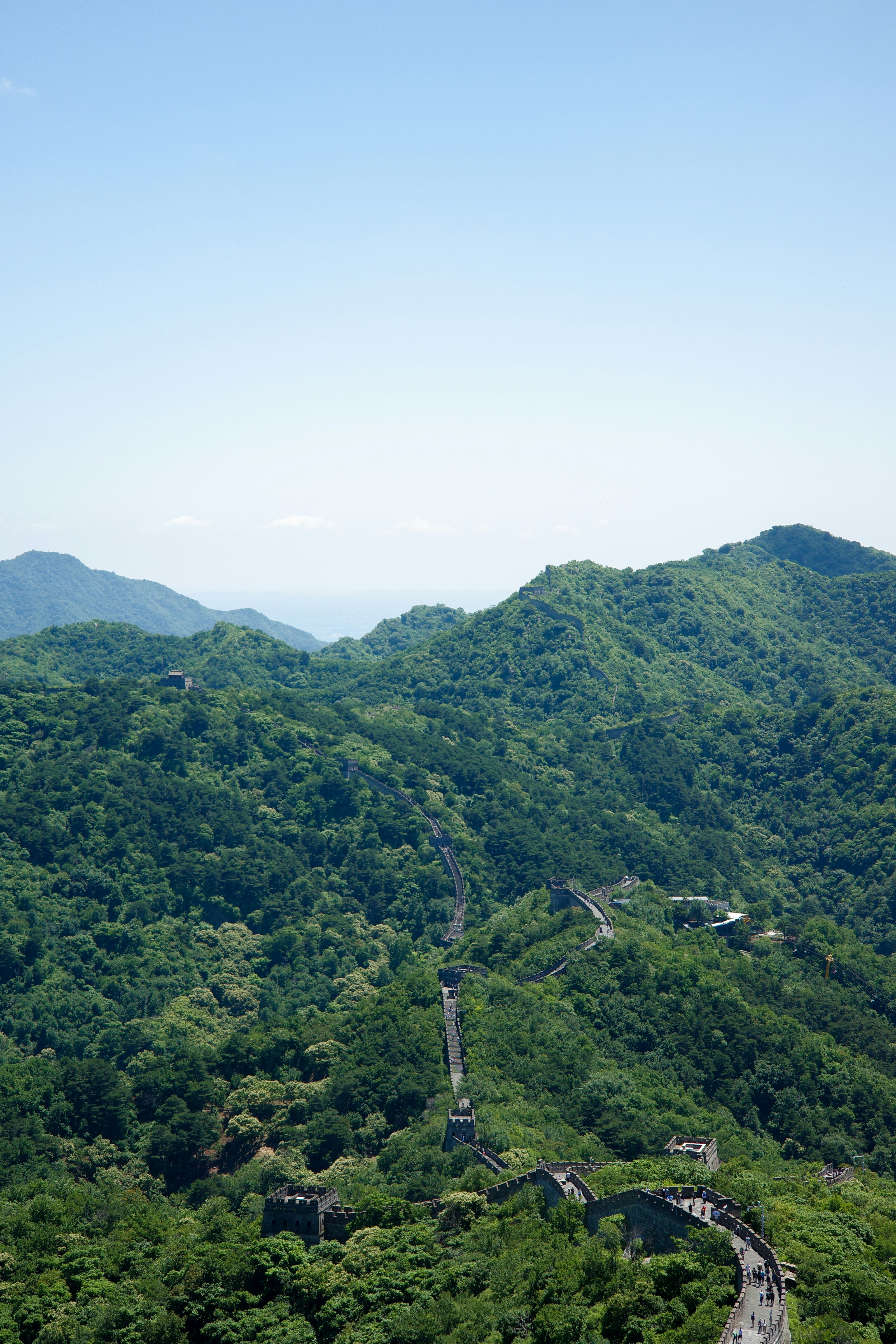 Curved Wall Through a Lush Mountain Ridge