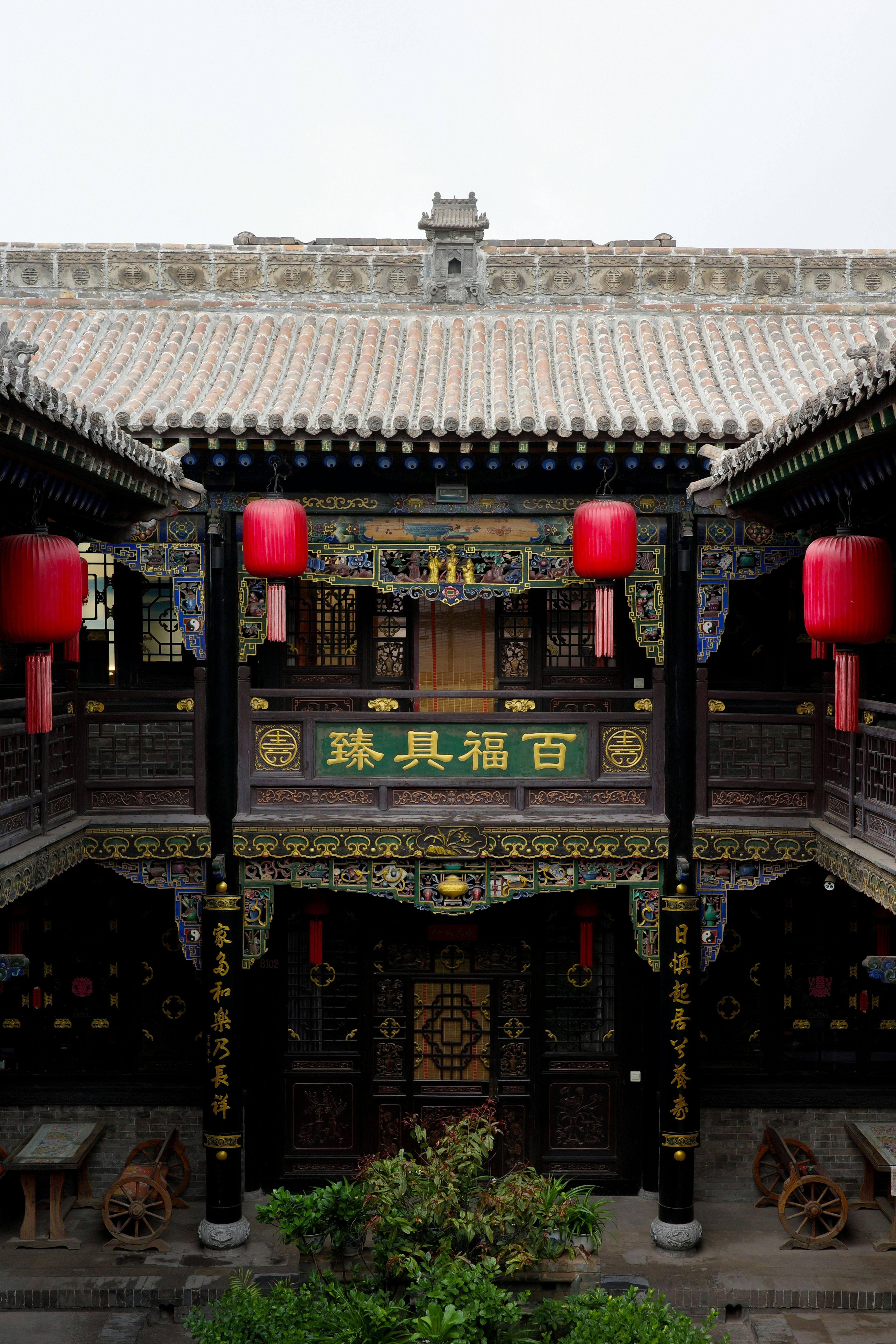 Ornate Courtyard of a Chinese Temple Gate with Red Lanterns