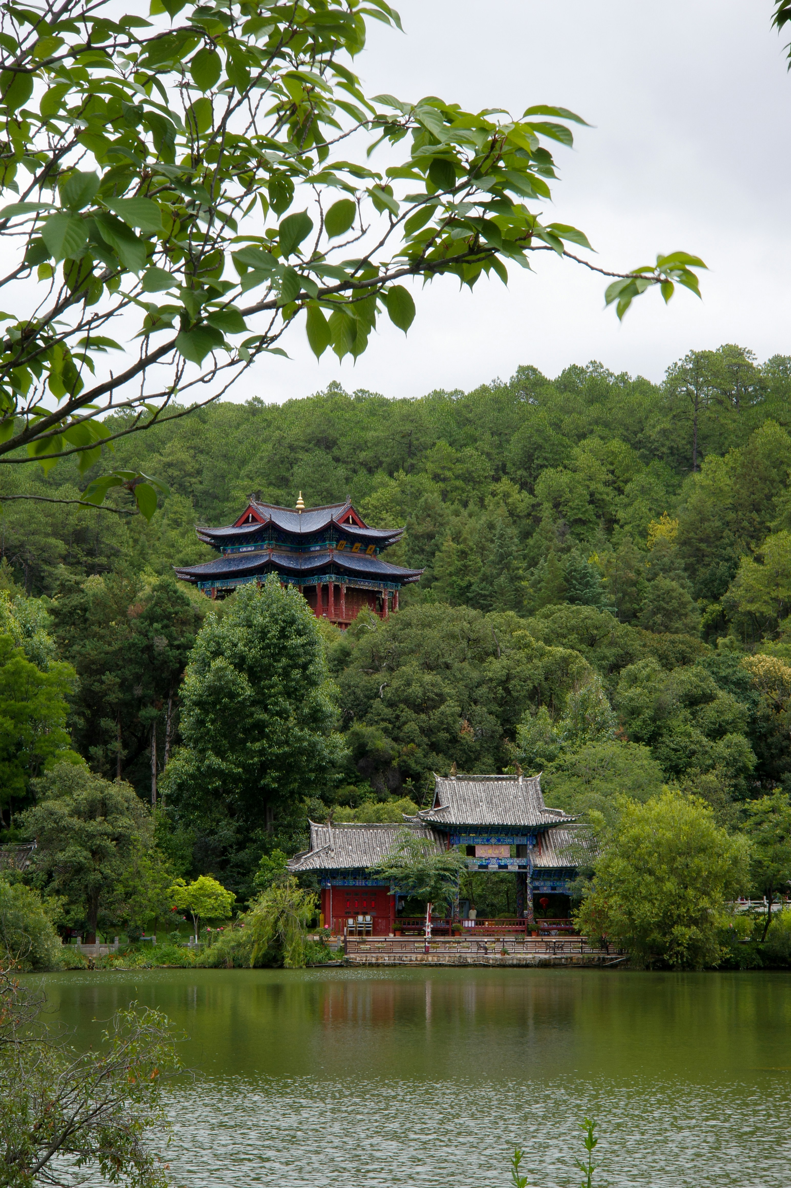 Emerald temple perched above a serene lakeside
