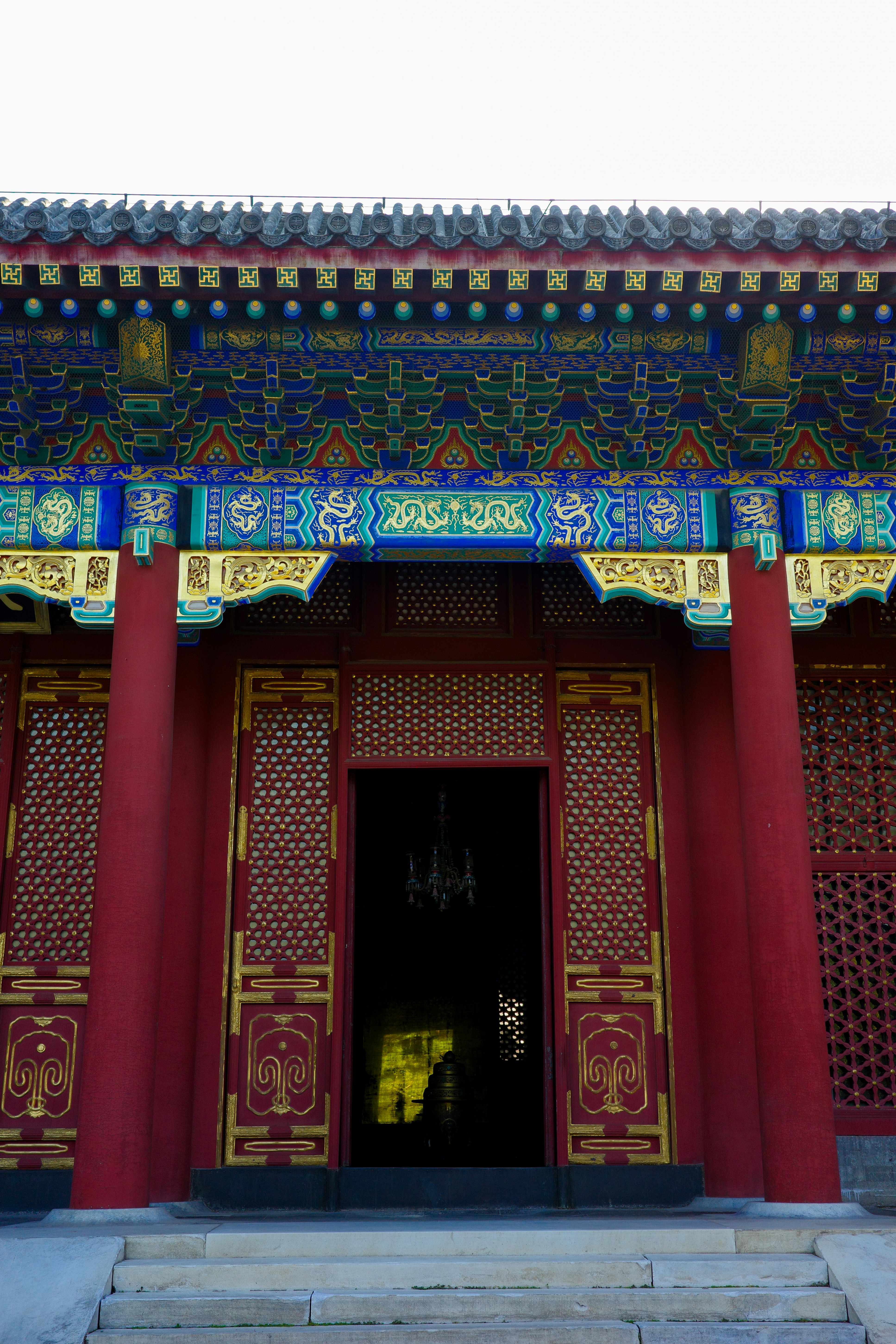 Red Doors and Ornate Frieze: Entry into a Chinese Temple