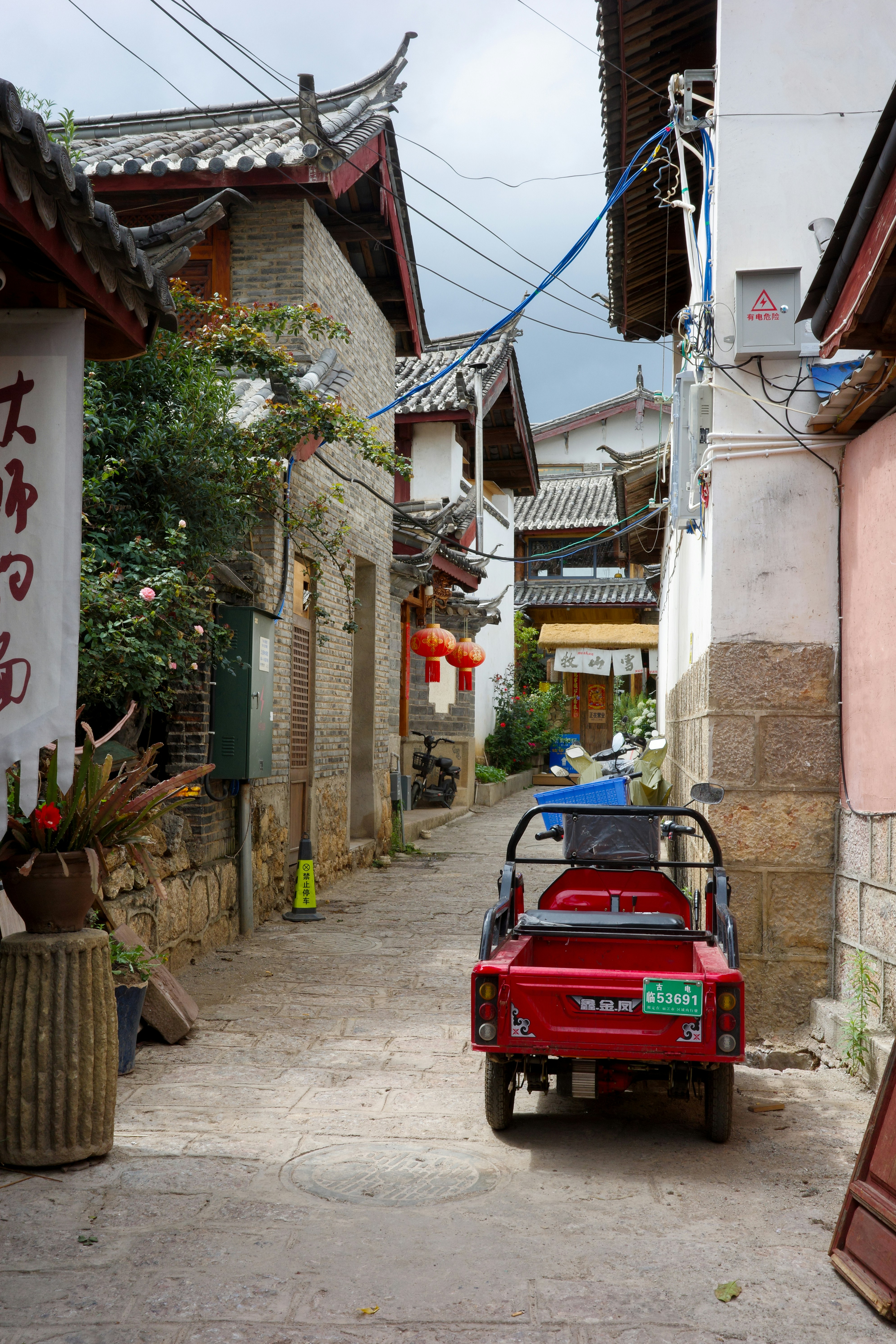 Red Mini Car at a Quiet Alley in a Traditional Town