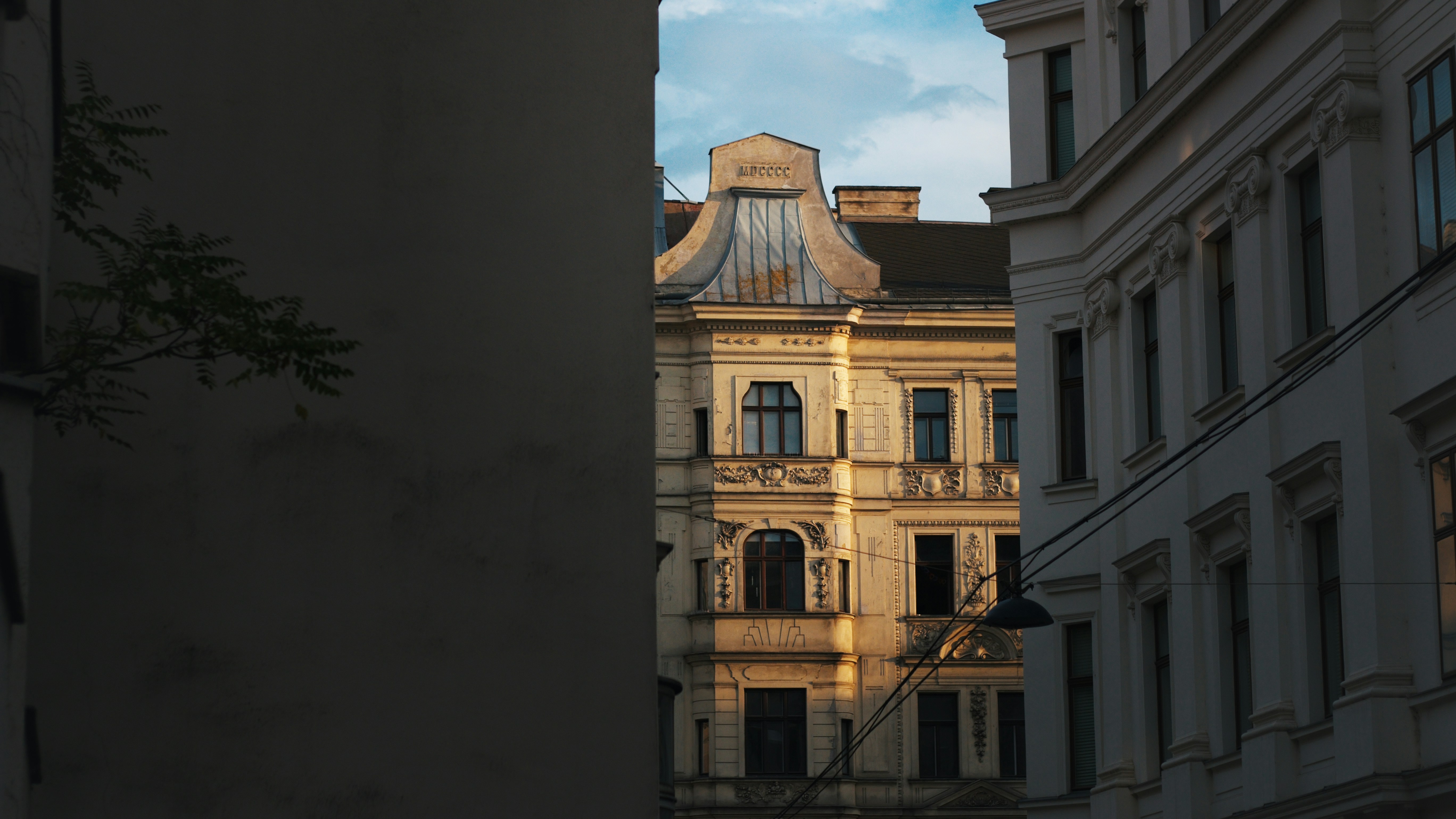 Sunlit Facade Piercing a Narrow Alley