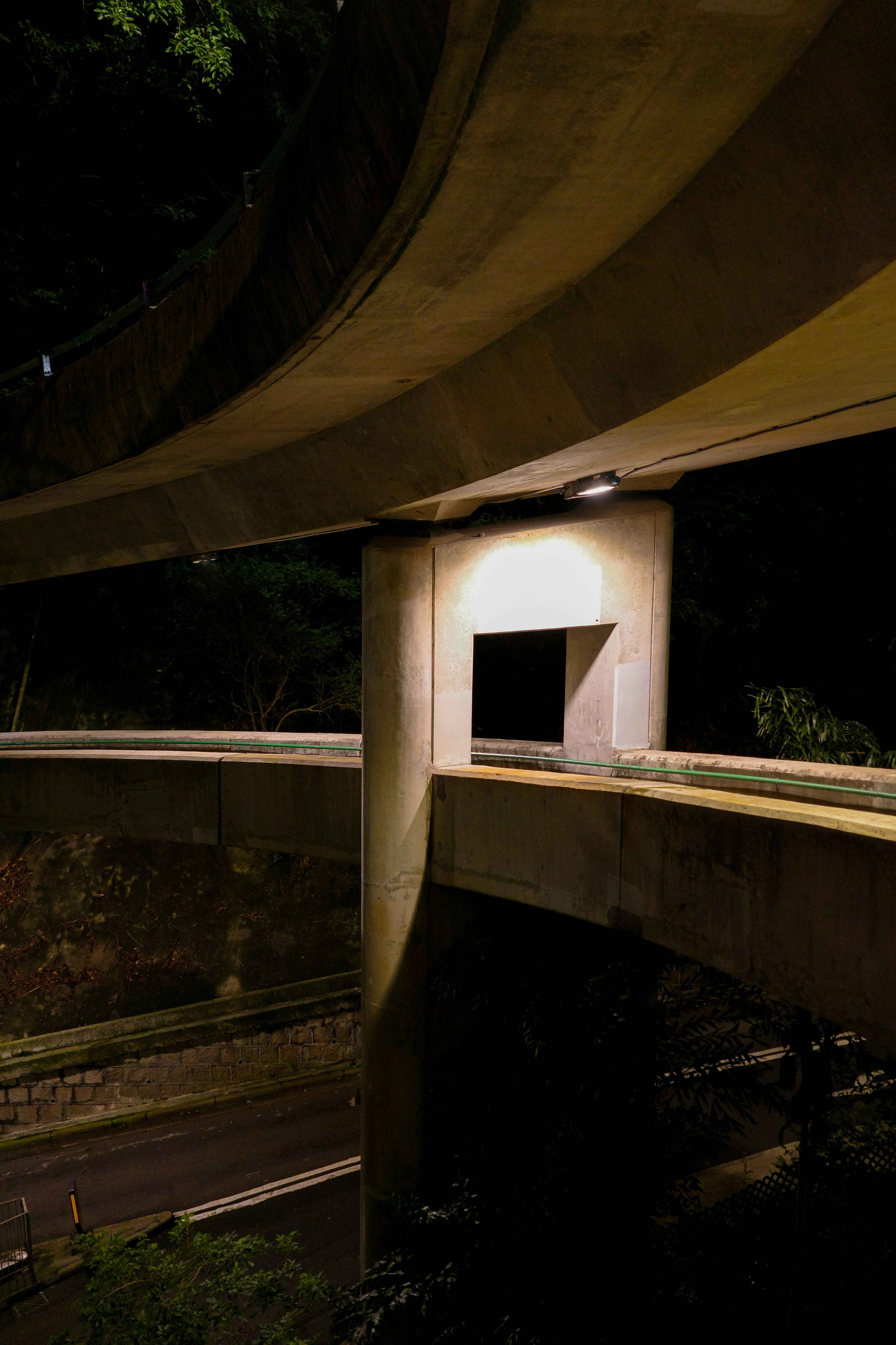 Concrete Overpass Arc: Night Light Illuminates a Quiet Passage