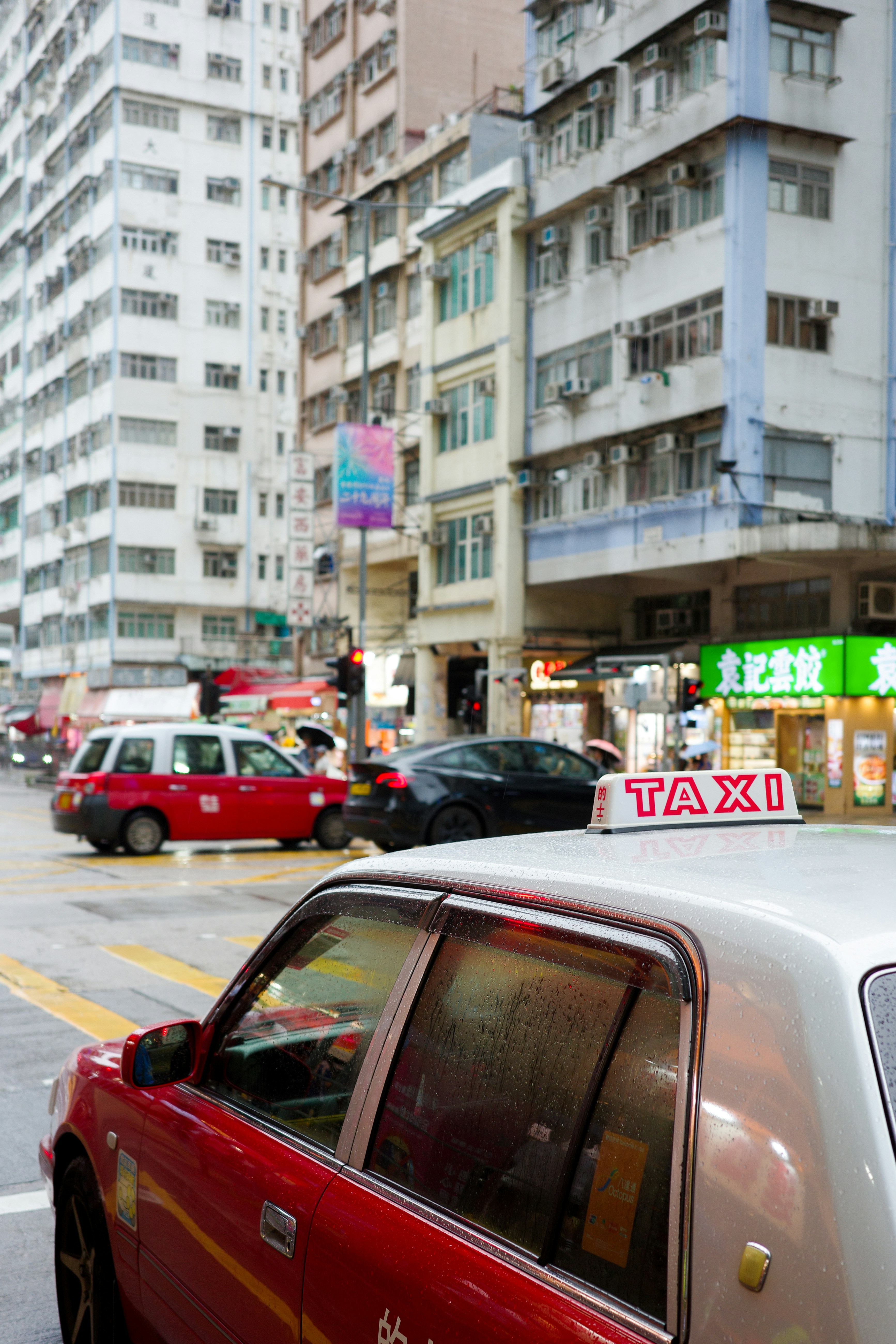 Street Pulse: Taxis and Neon Across a Rainy Kowloon Row