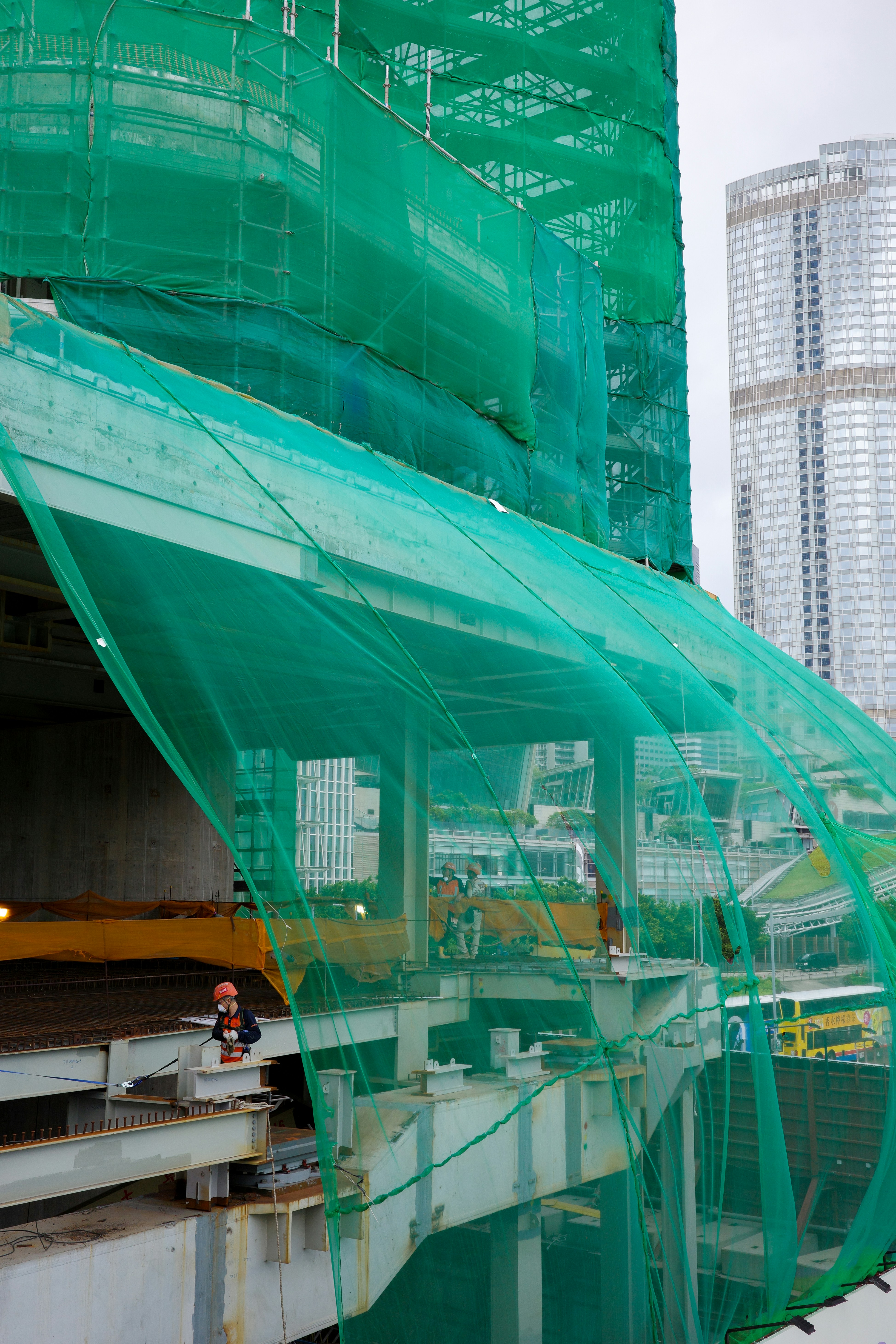 Green Mesh Veil over Urban Construction: A Glimpse of Progress