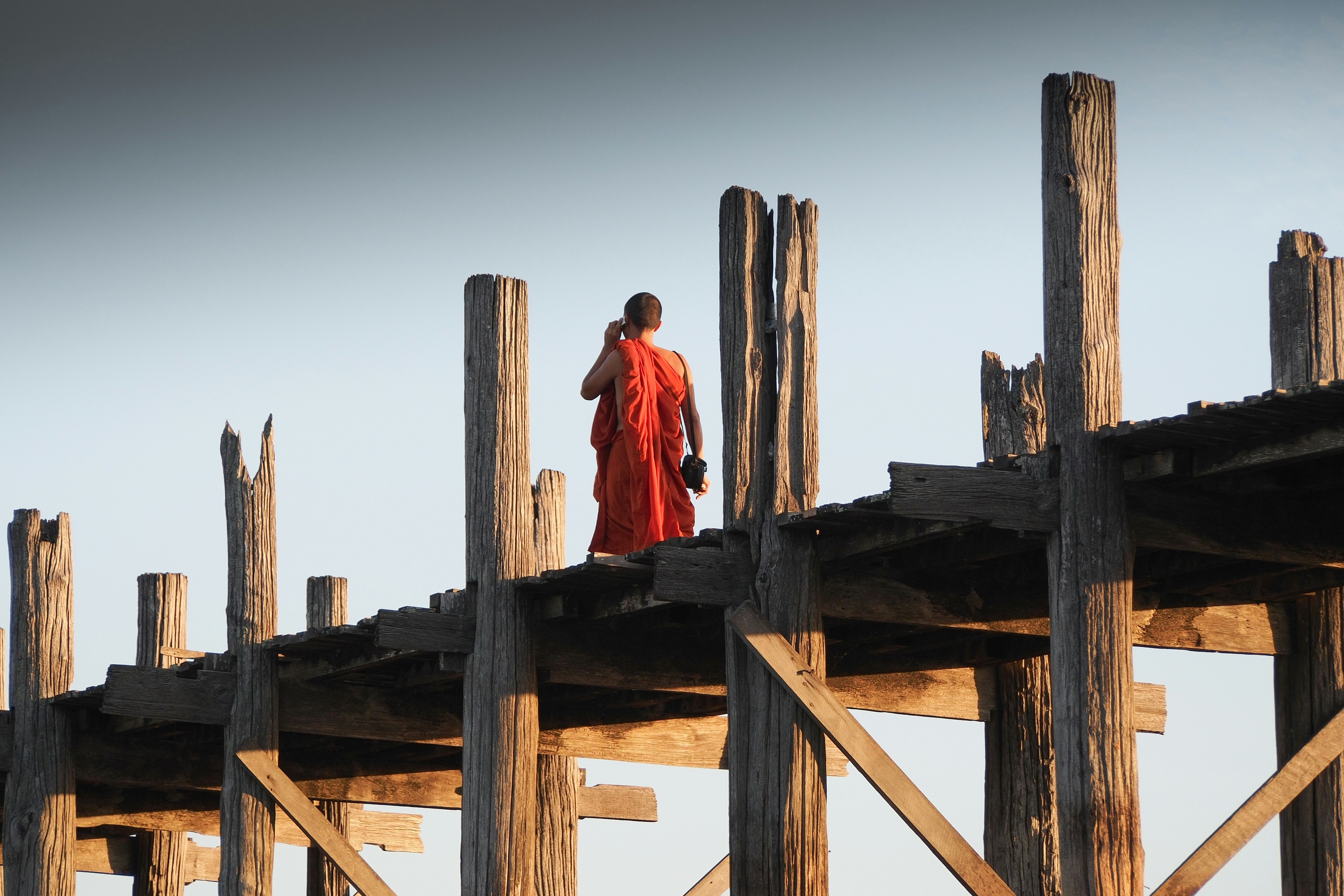Monk on the Timber Walkway at Sunset