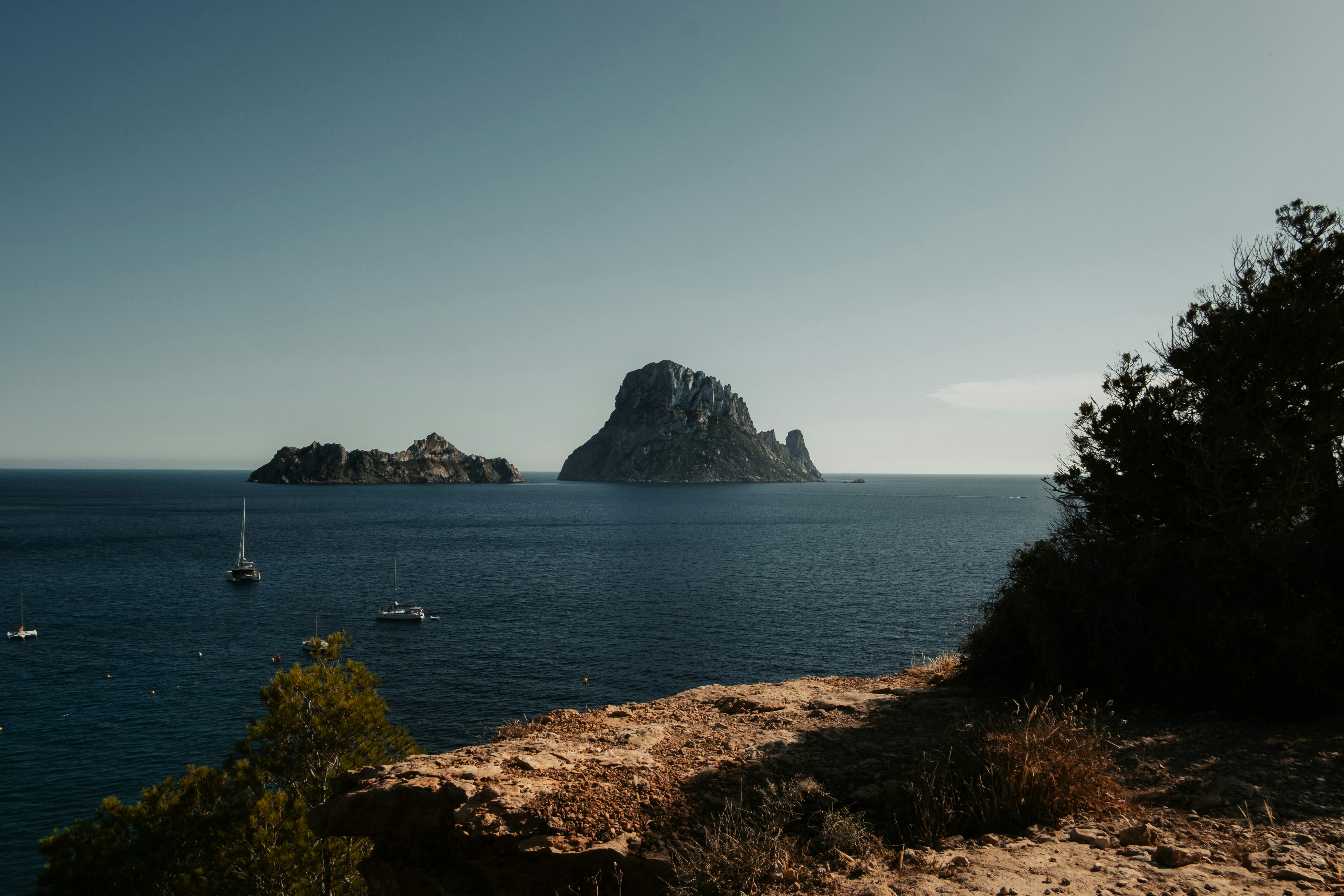 Islands on a Quiet Sea: A Coastal Vista with Sailboats