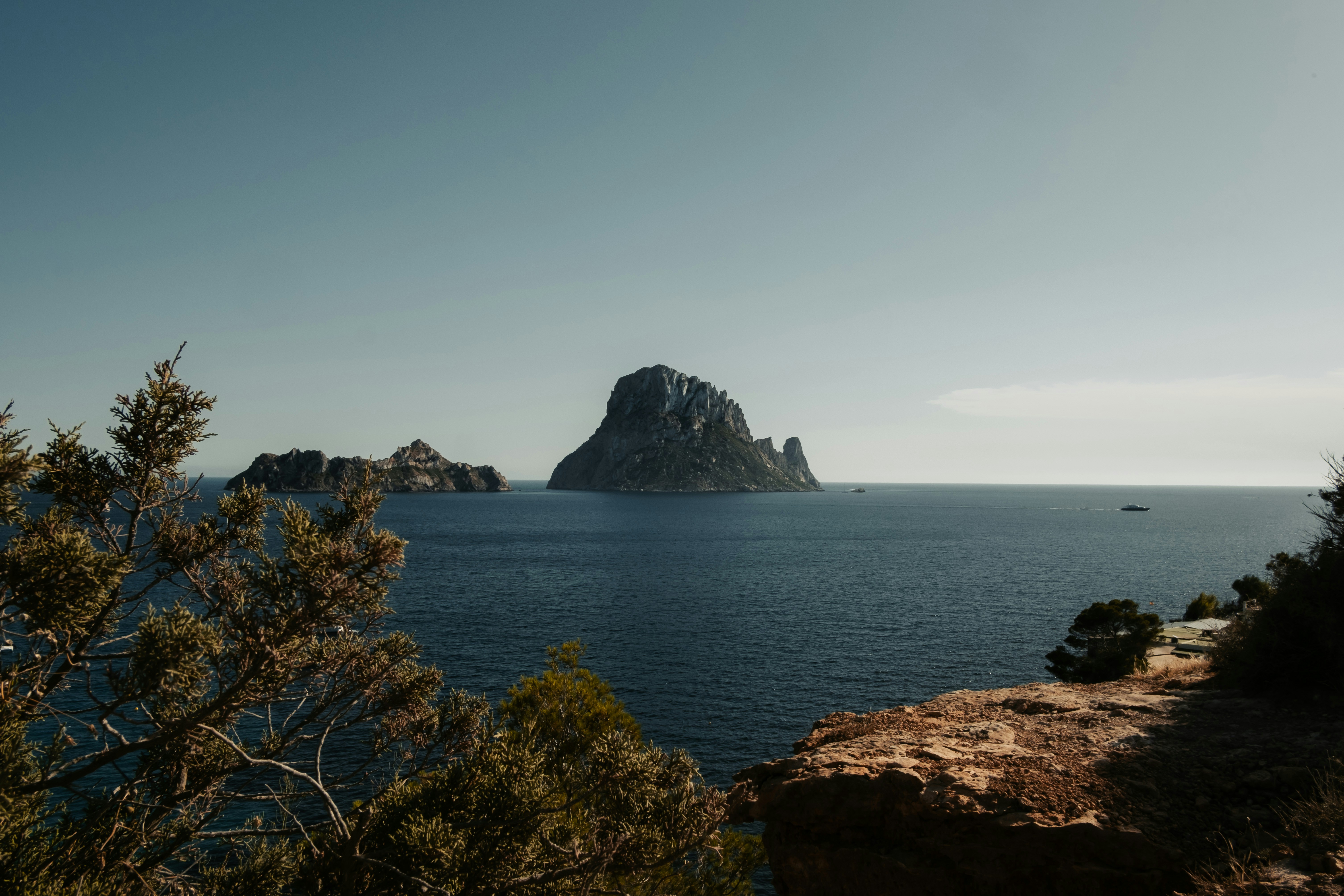 Island Sentinel: A rocky islet rising from calm deep blue