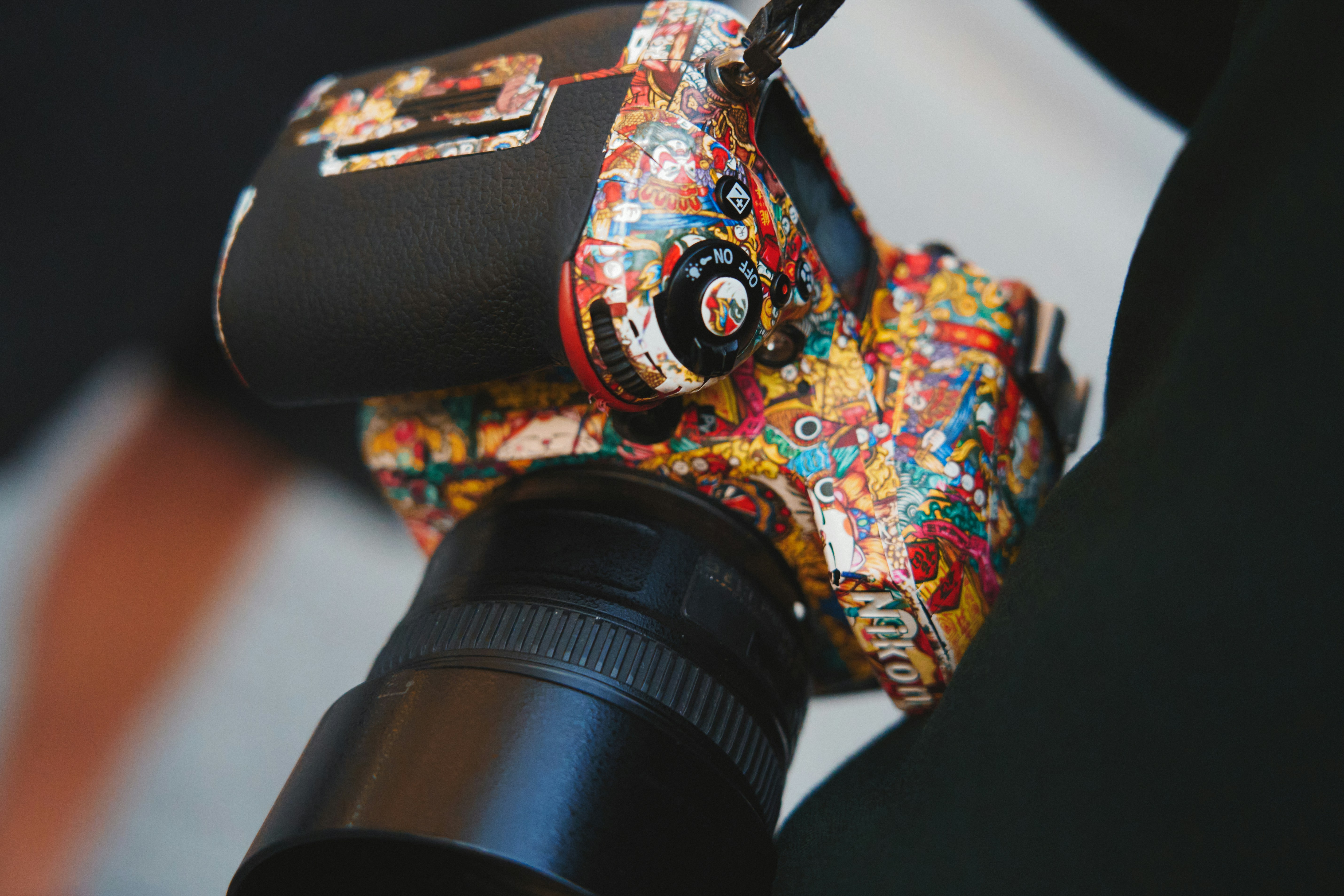 Cosmic graffiti on a camera: a close-up of a colorful lens wrap