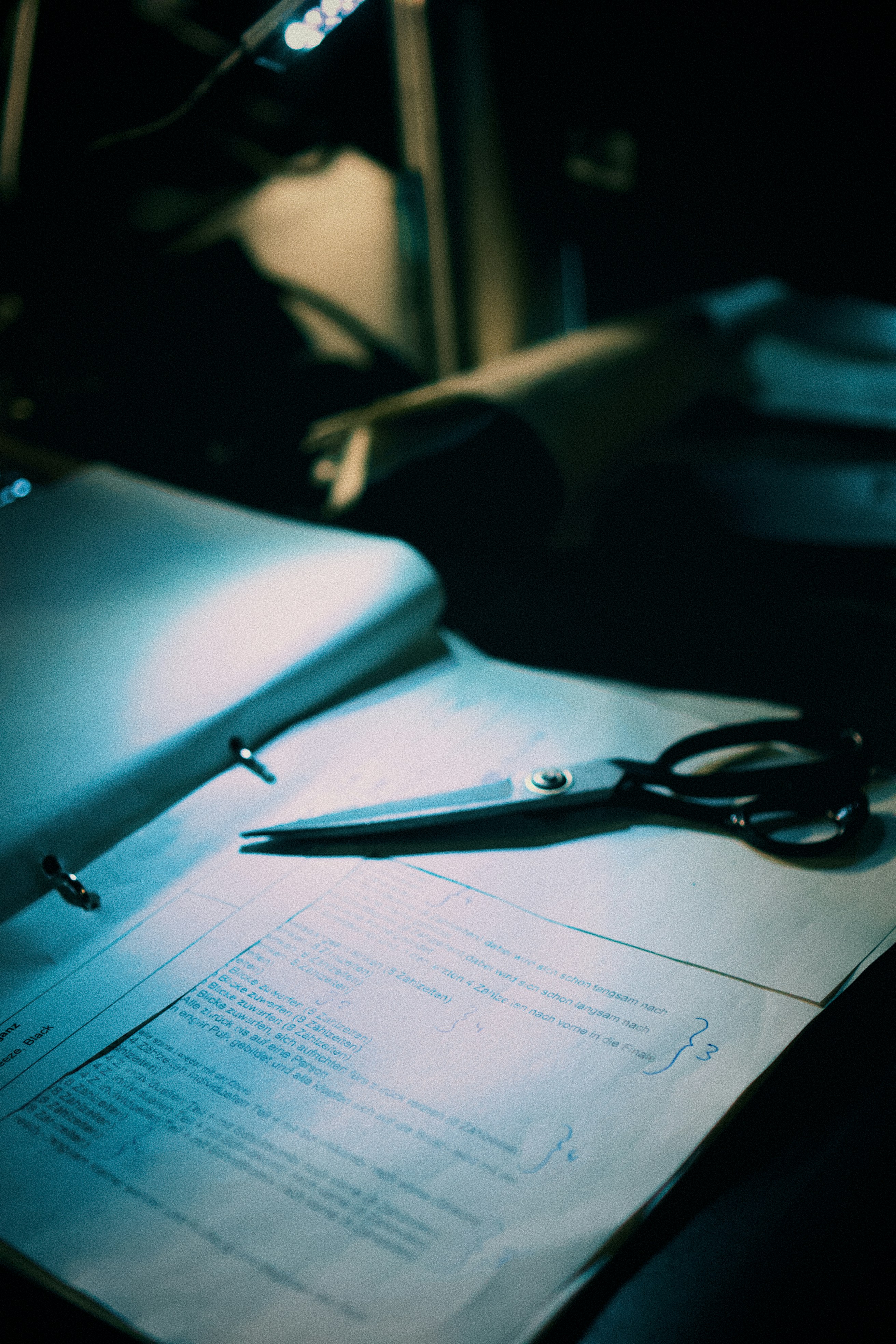 Scissor’s Edge over a Desk of Plans