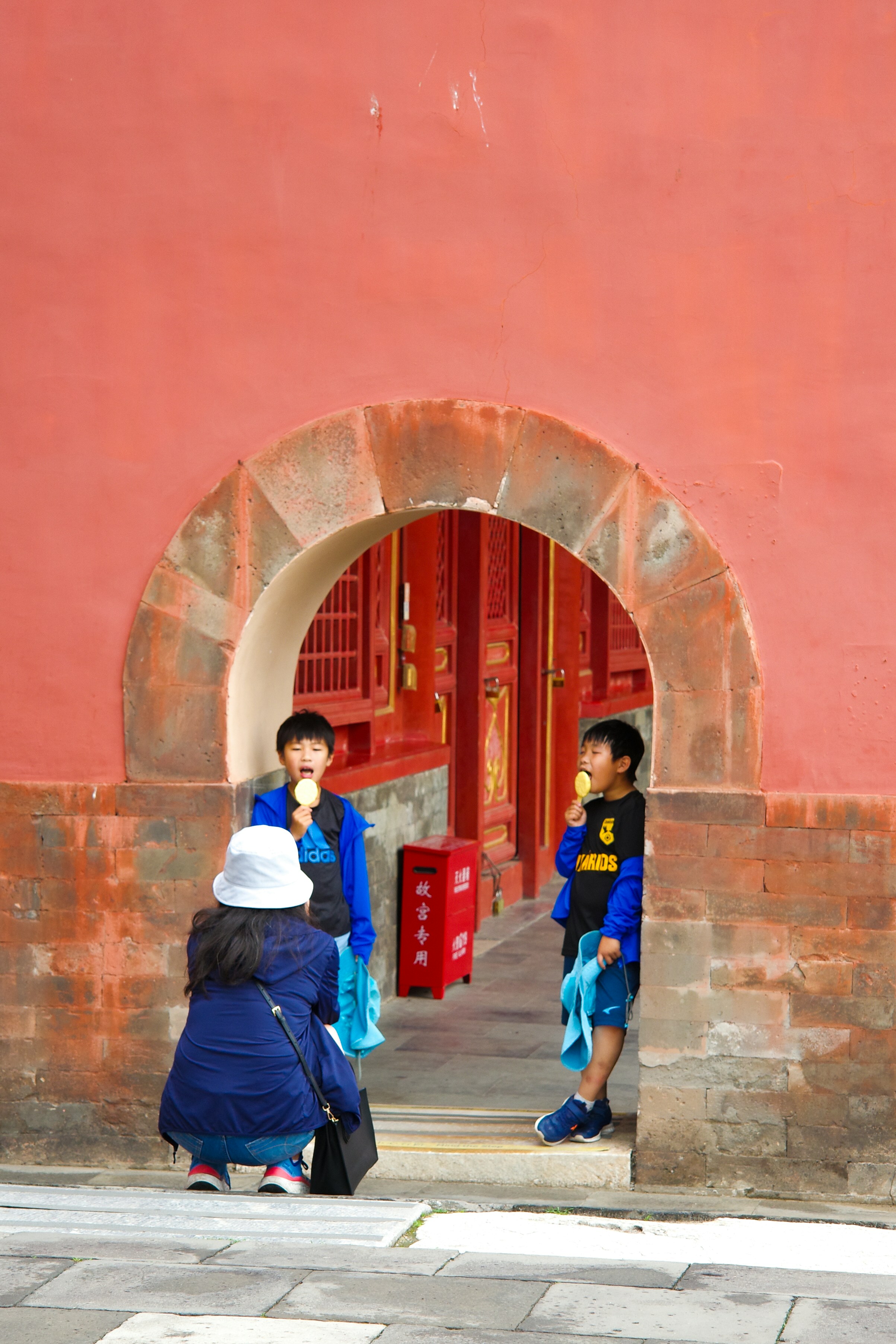 Three Figures at the Temple Gate: Ice Cream Break by the Arch