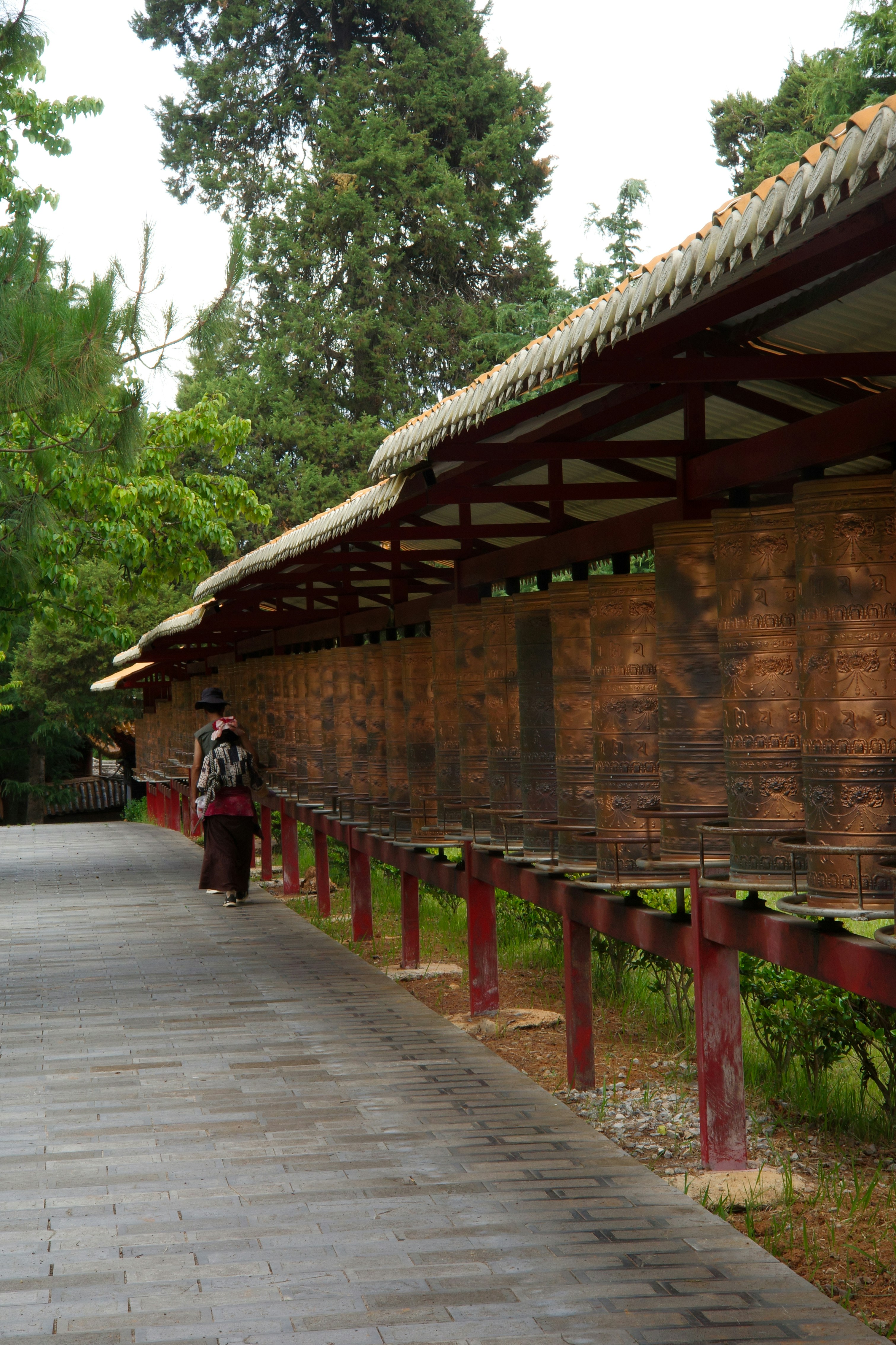 Quiet Ritual Under Wooden Eaves: A Traveler in the Shadowed Corridor