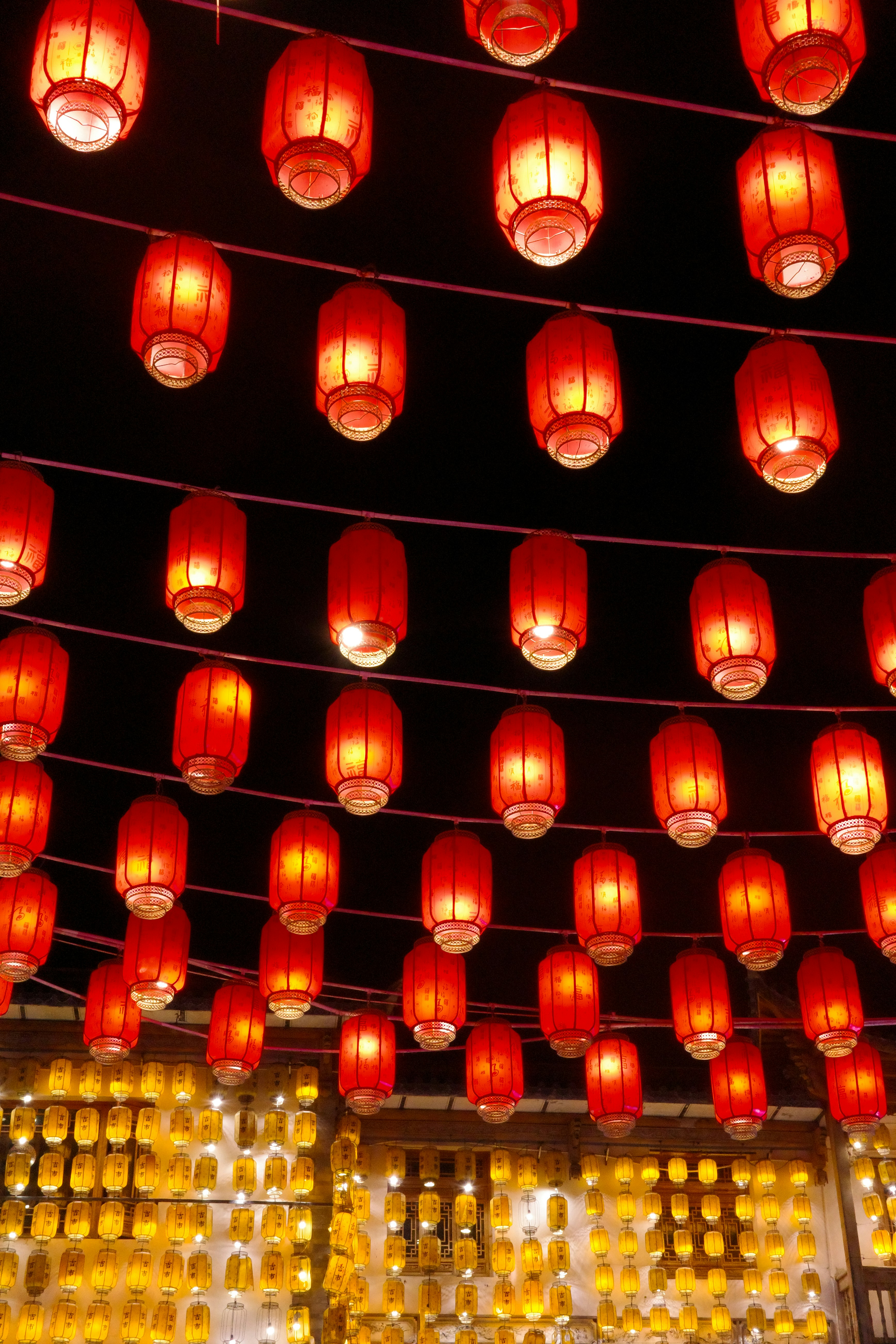 Lantern Veil: Red Orbs Adorning a Night Bazaar