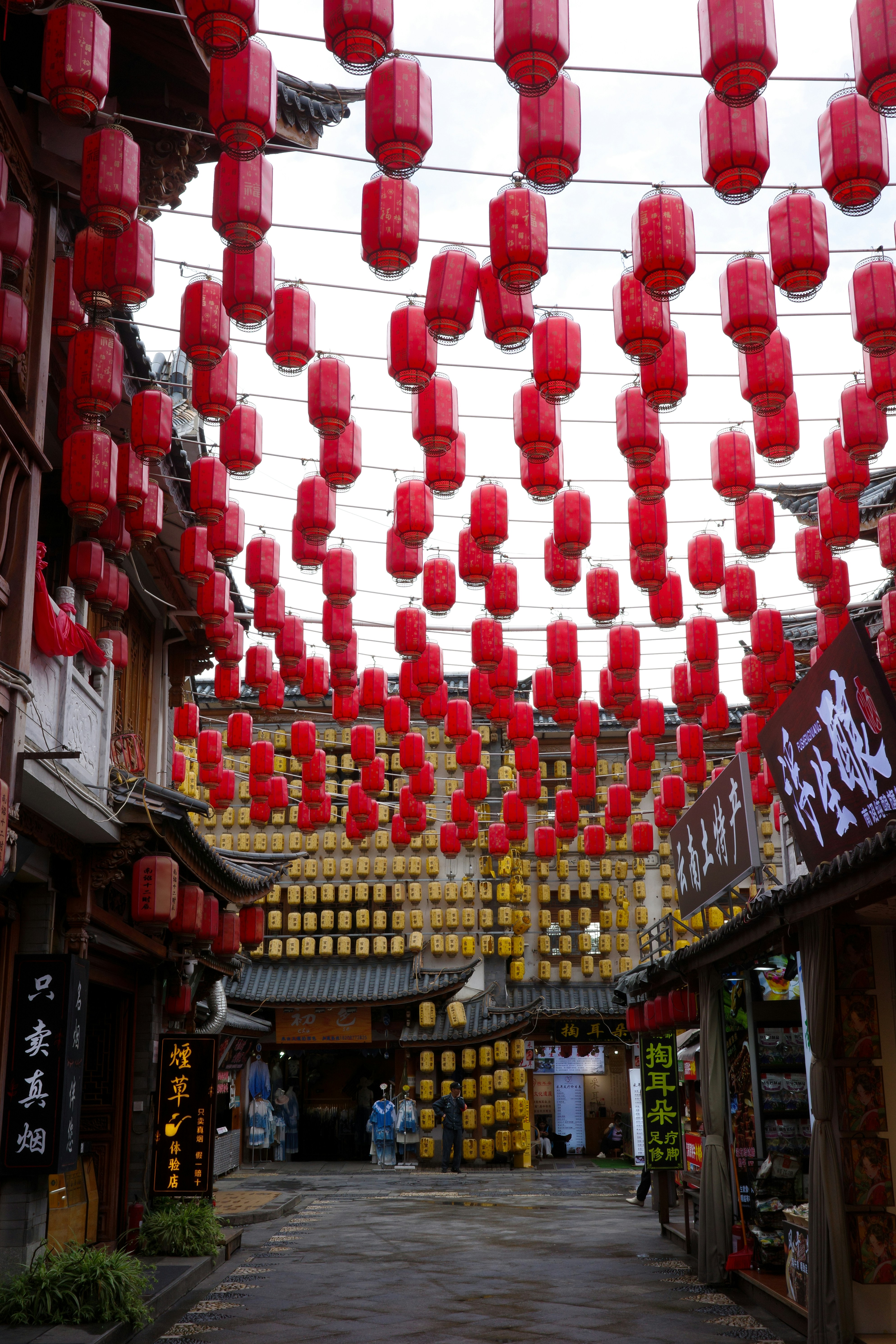 Lantern Corridor: A Tapestry of Red and Gold Over an Everyday Market