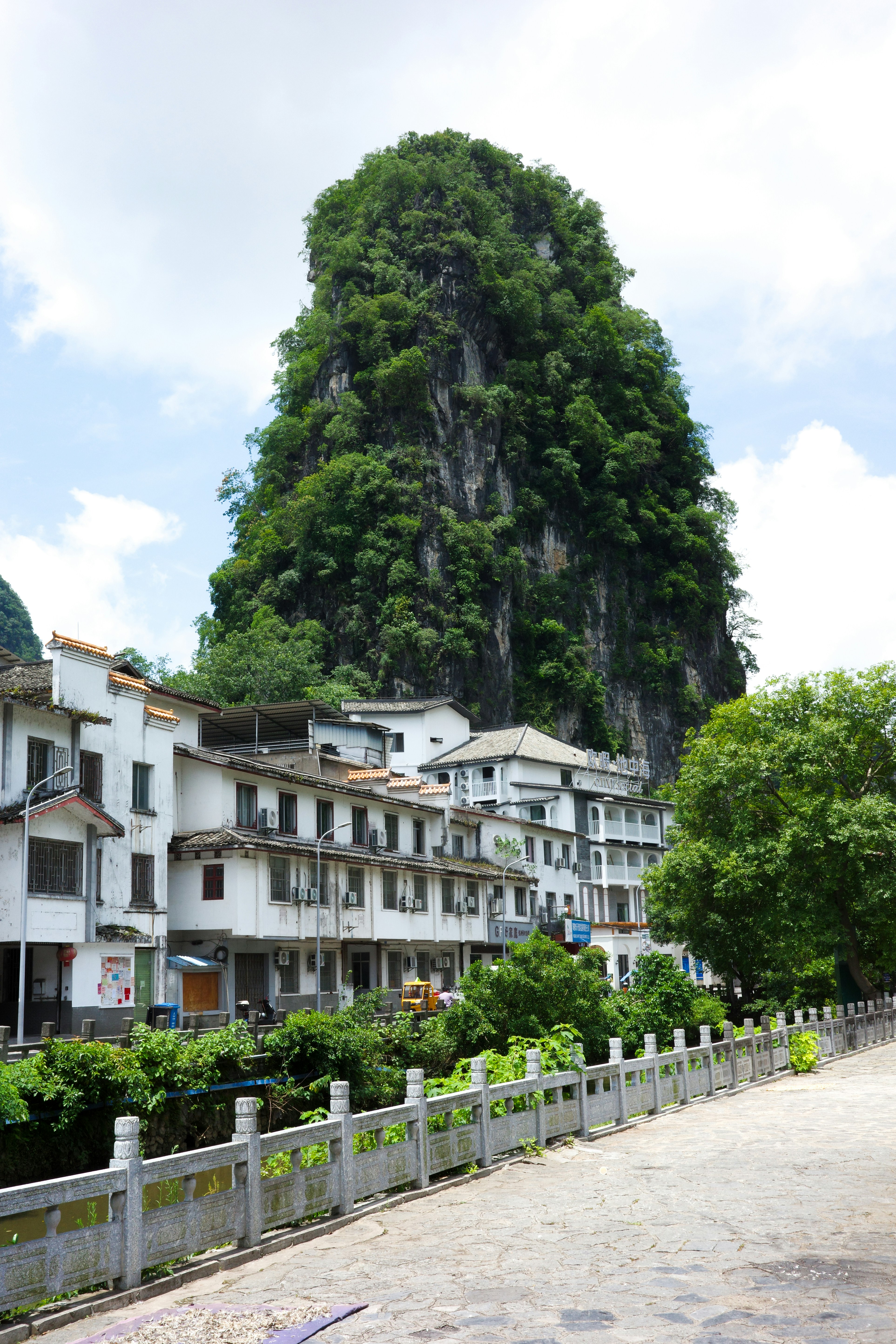 Limestone Monolith Rising Behind a Quiet Waterfront Village