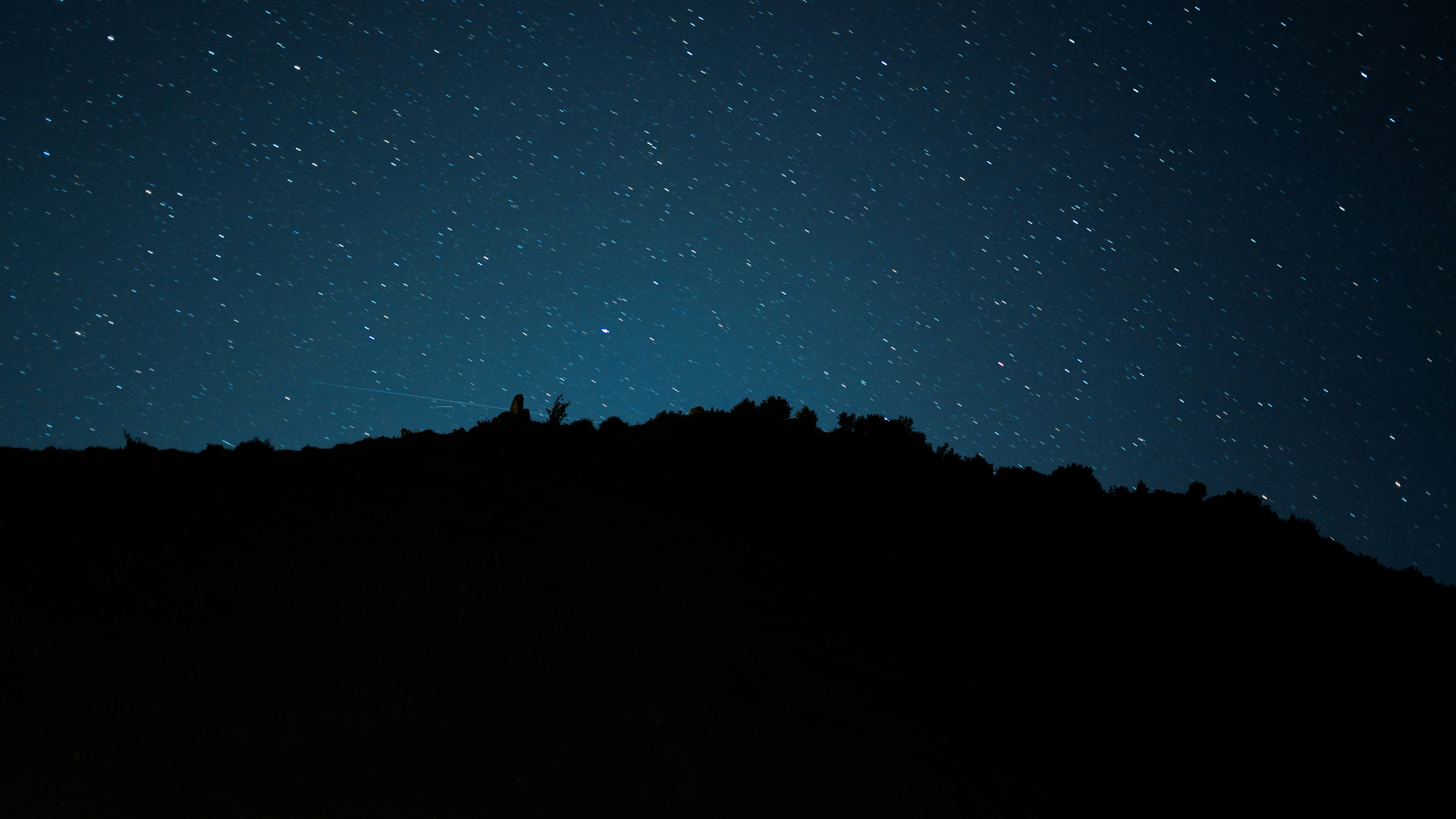Silhouette Crest Beneath a Starry Veil