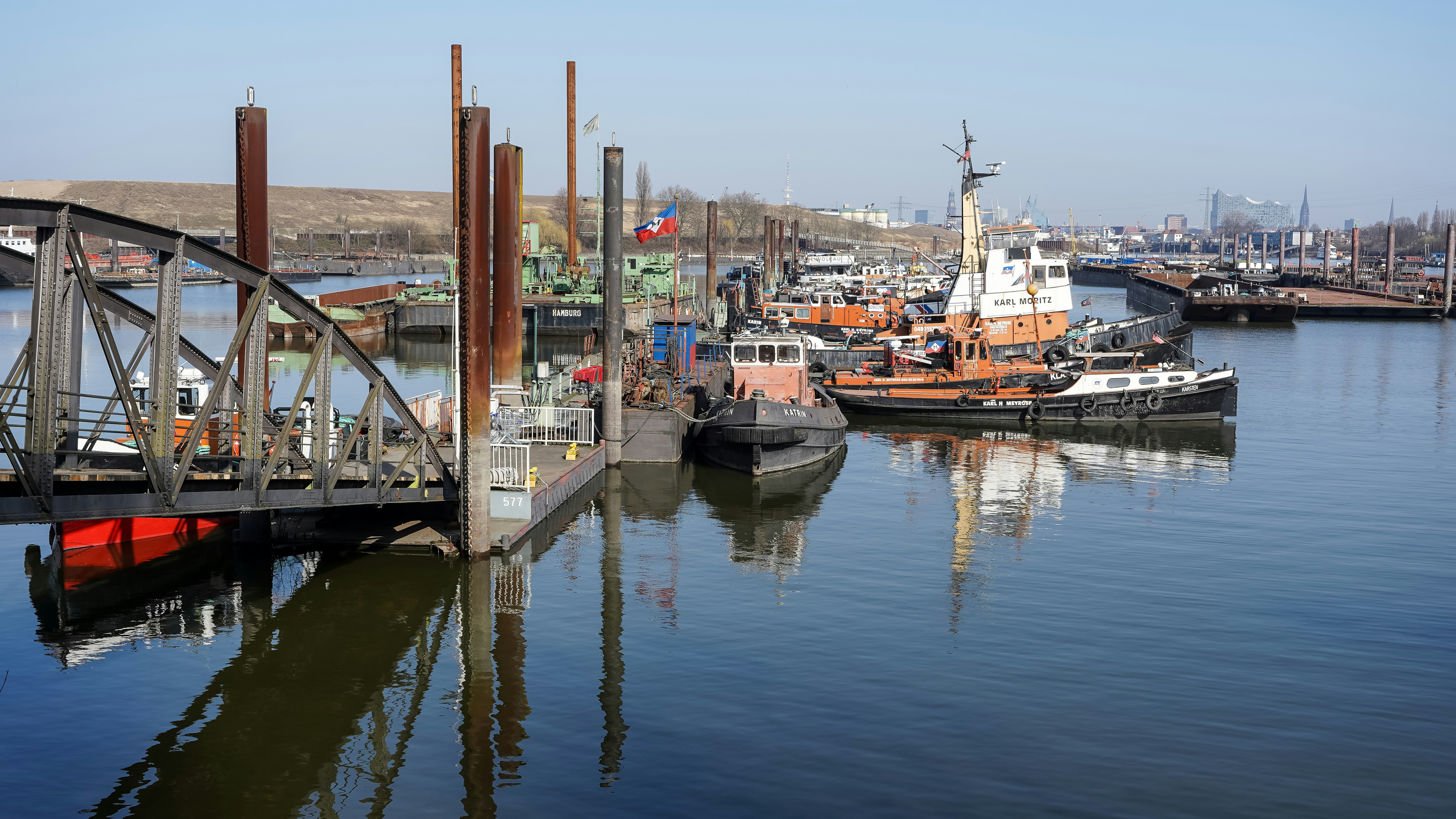 Harbor Machinery: Boats and a Spun-Wrown Pier under Clear Sky