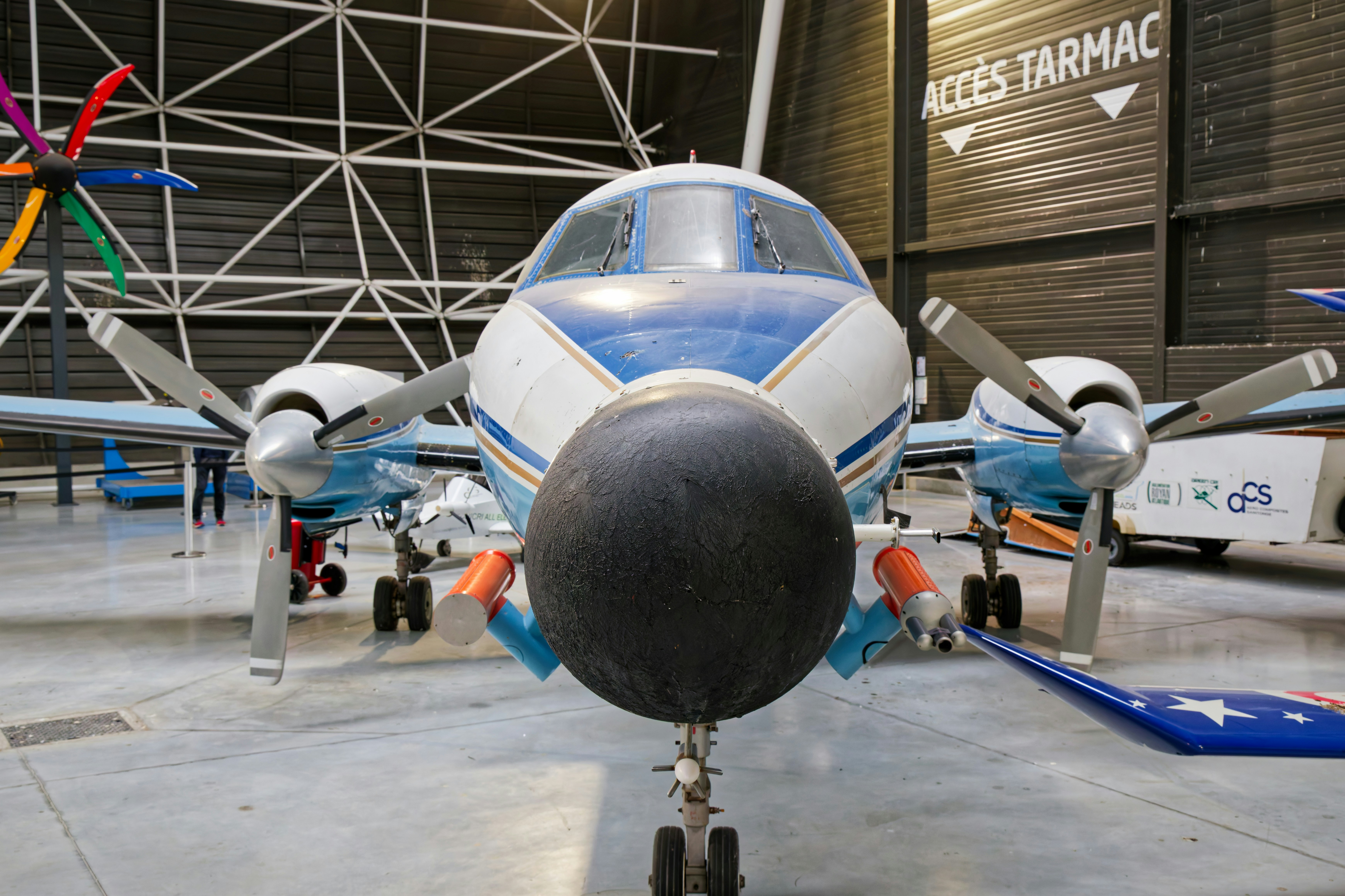 Front View of a Vintage Jet in a Maintenance Hangar