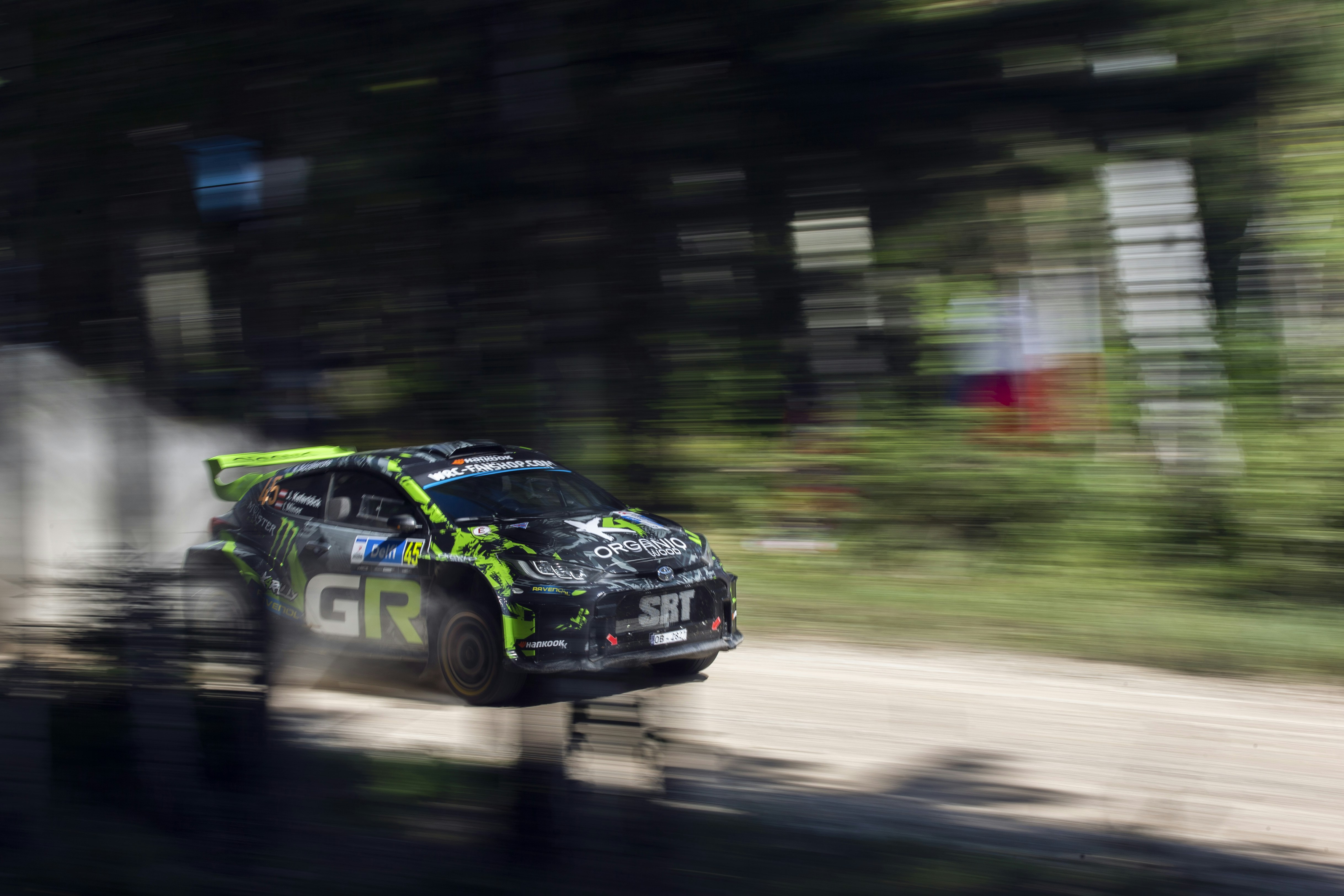 Green Monster Rallies Through a Blurred Forest Sprint