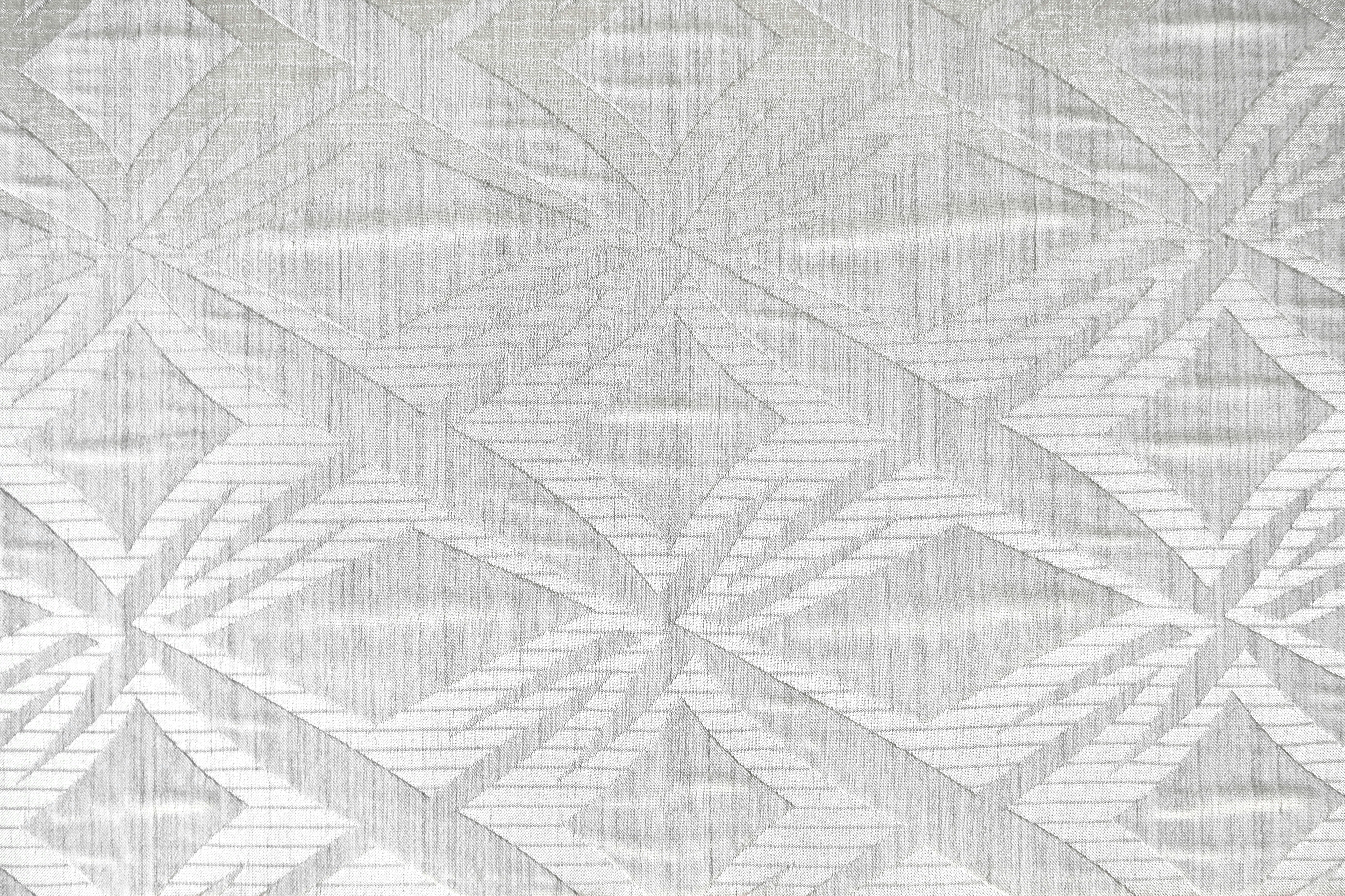 Monochrome geometric pattern filling the frame, emphasizing repeating chevron-like motifs and subtle texture variation. A textile-like abstract composition with no distinct subject.