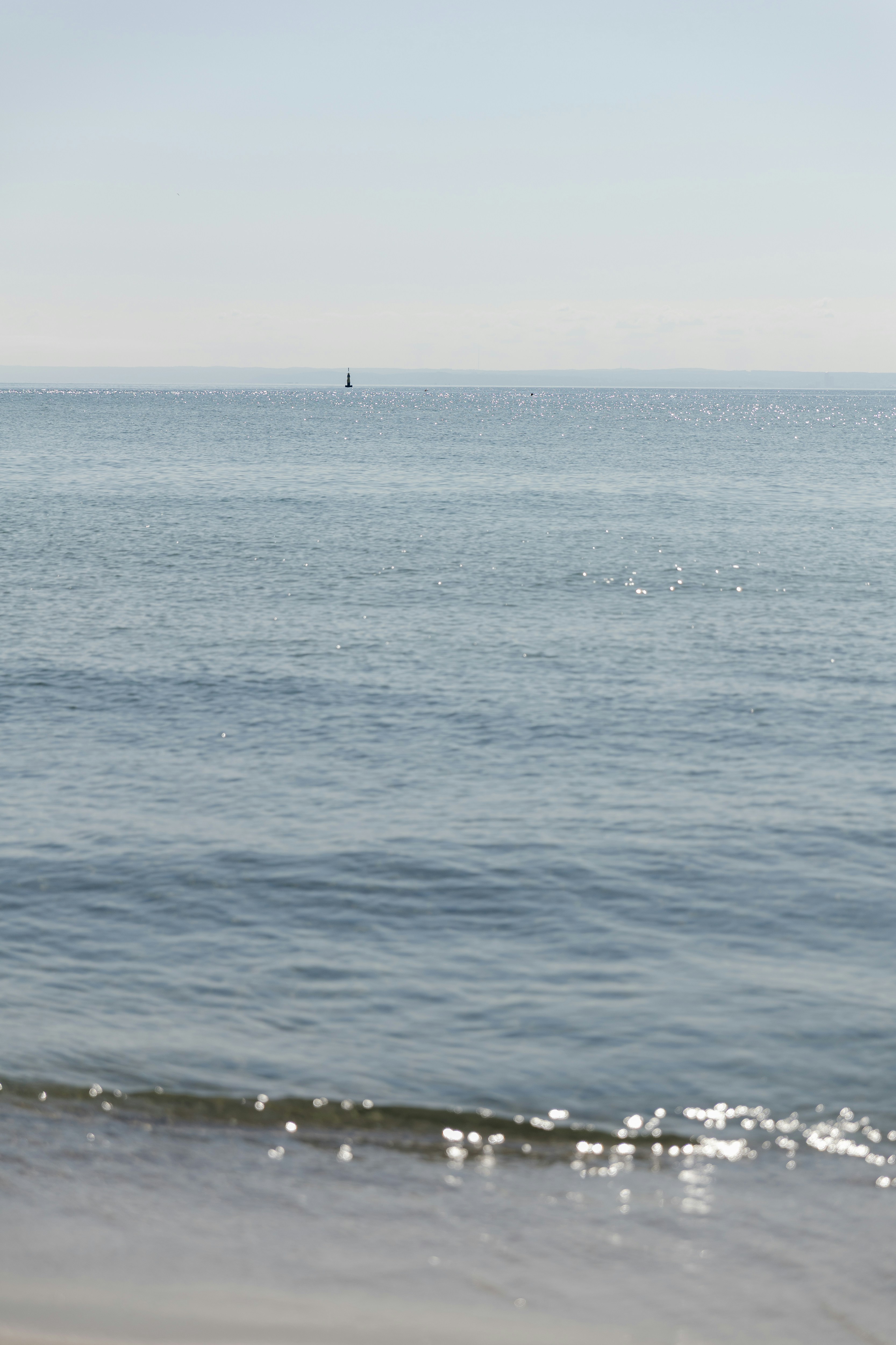 Horizon Needle: A Lone Buoy Above A Quiet Sea