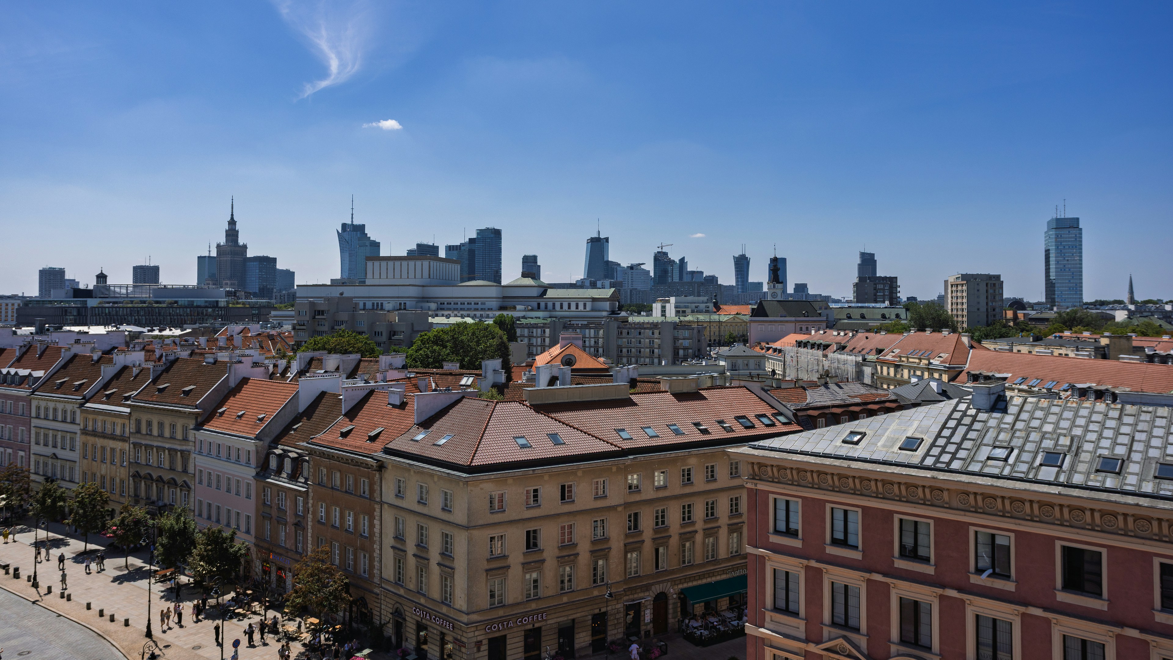 Cityscape Crown: Rooftop Row Beneath a Clear Blue
