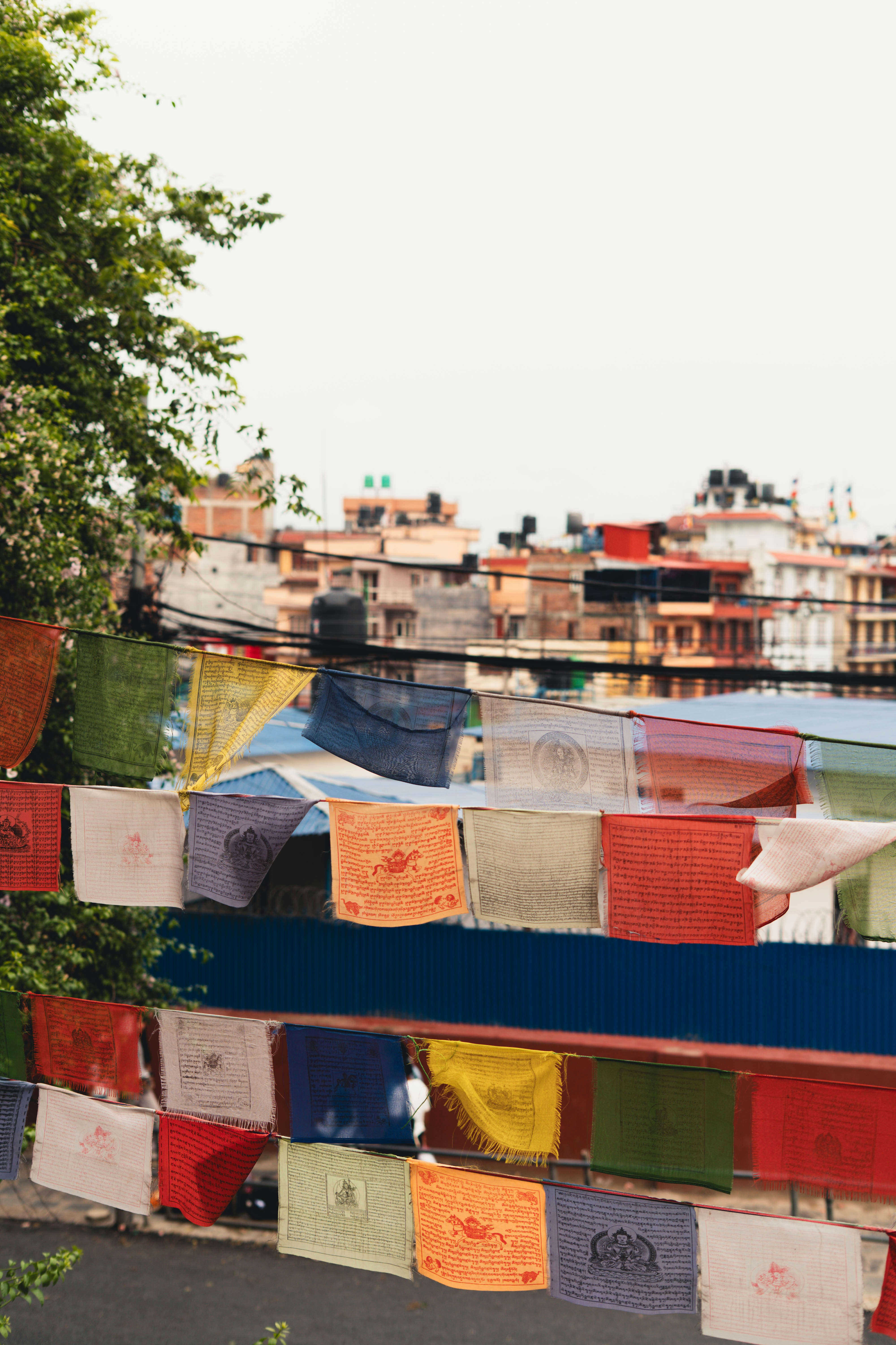 Colorful Prayer Flags Draped Over a Quiet Urban Rooftop