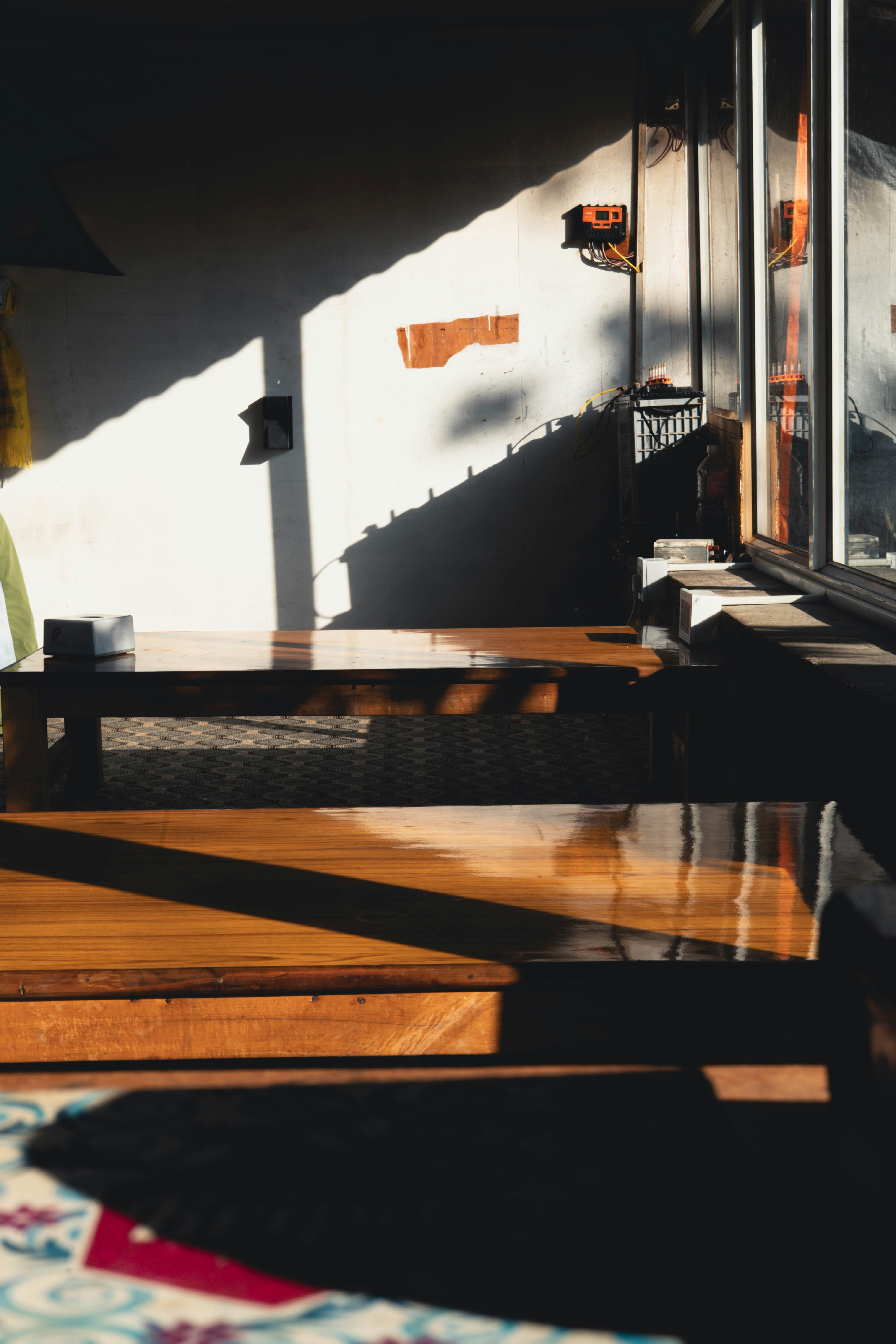 Sunlit Minimalism: Empty Tables Bathed in Sharp Shadows