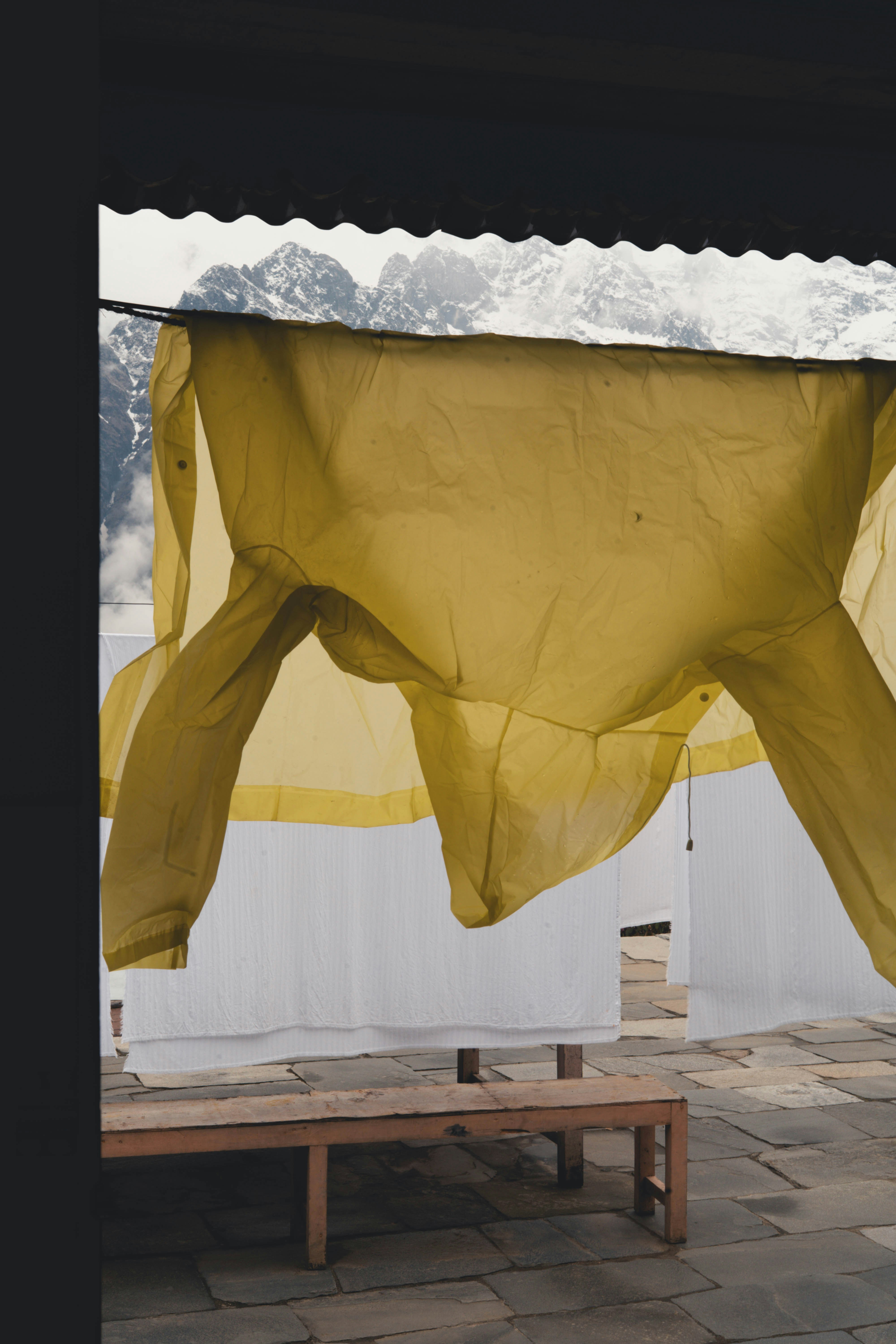 Floating Yellow Fabric Over a Tiled Terrace