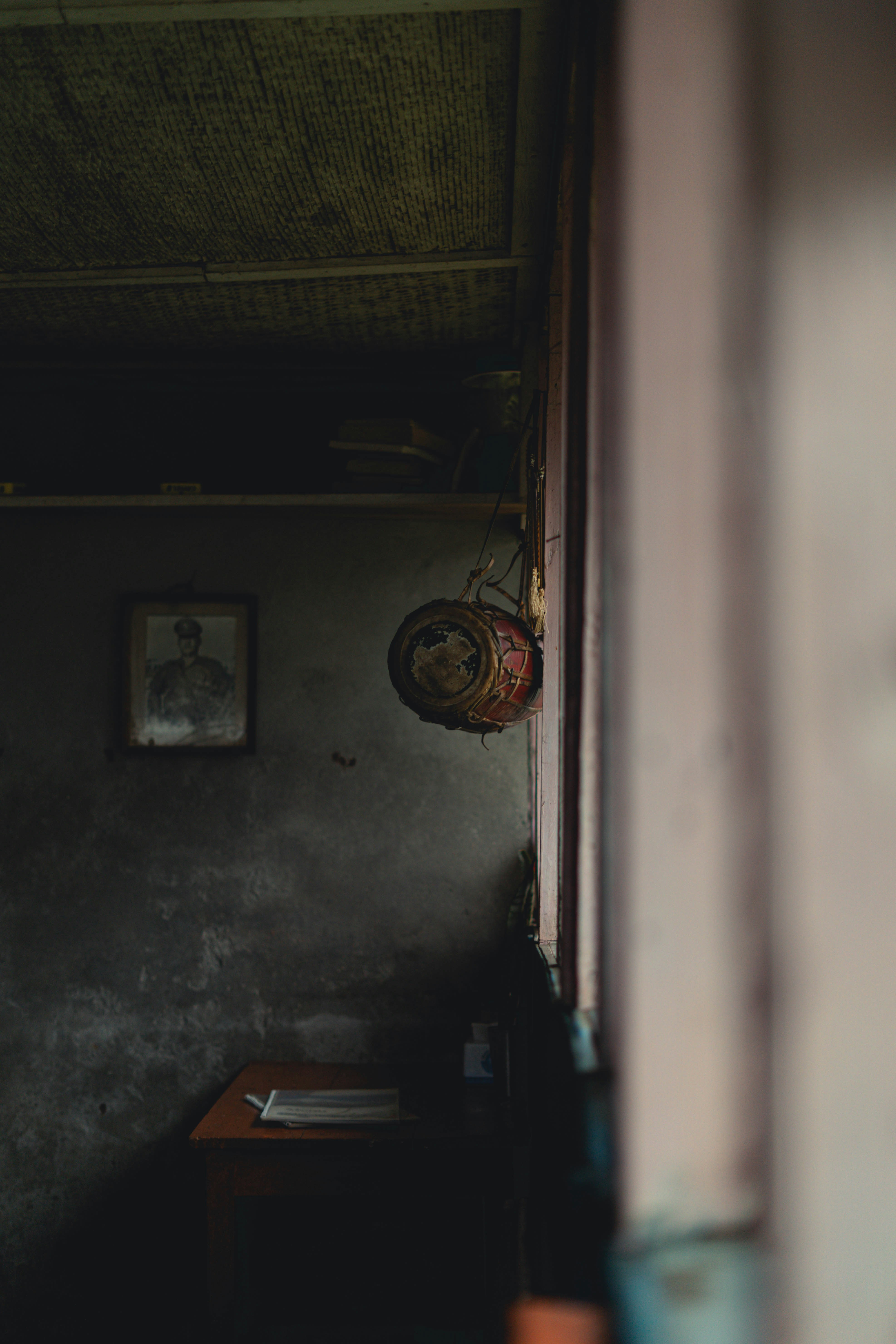 Dusty Room with Framed Portrait and Hanging Lantern