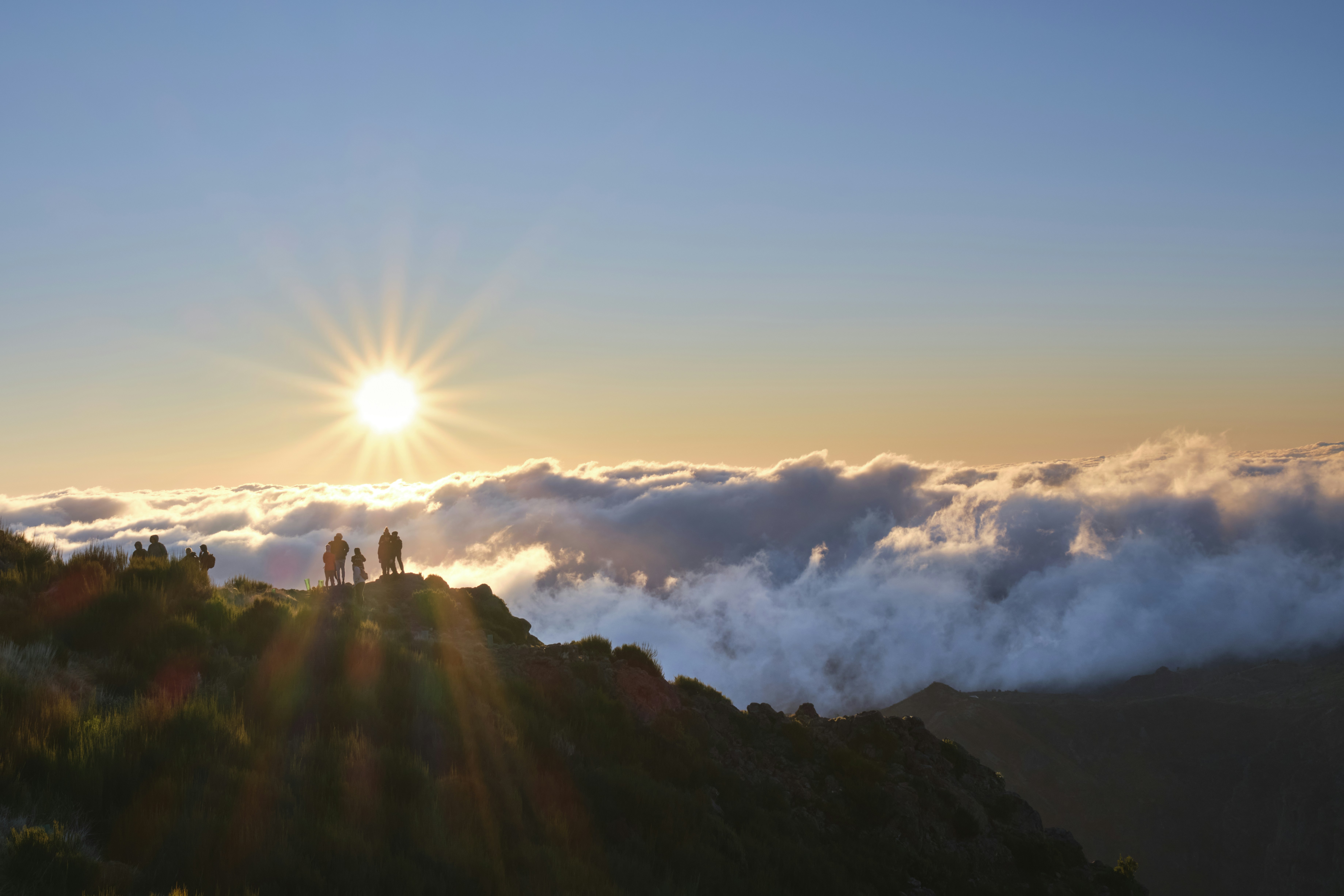 Sunrise Ridge: Figure Silhouettes Above a Sea of Clouds