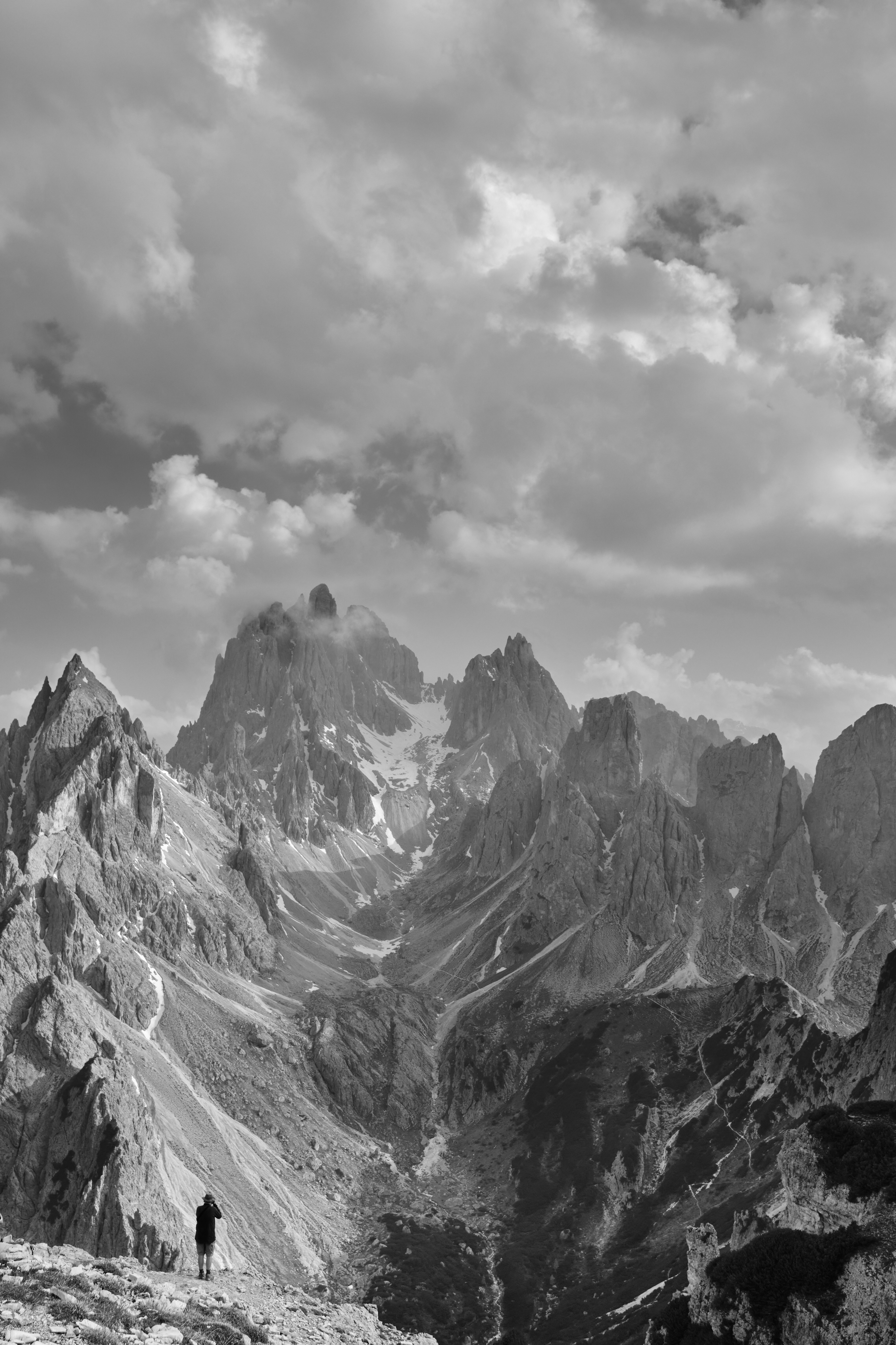 Where Earth Meets Sky: Lone Hiker Amid Jagged Peaks