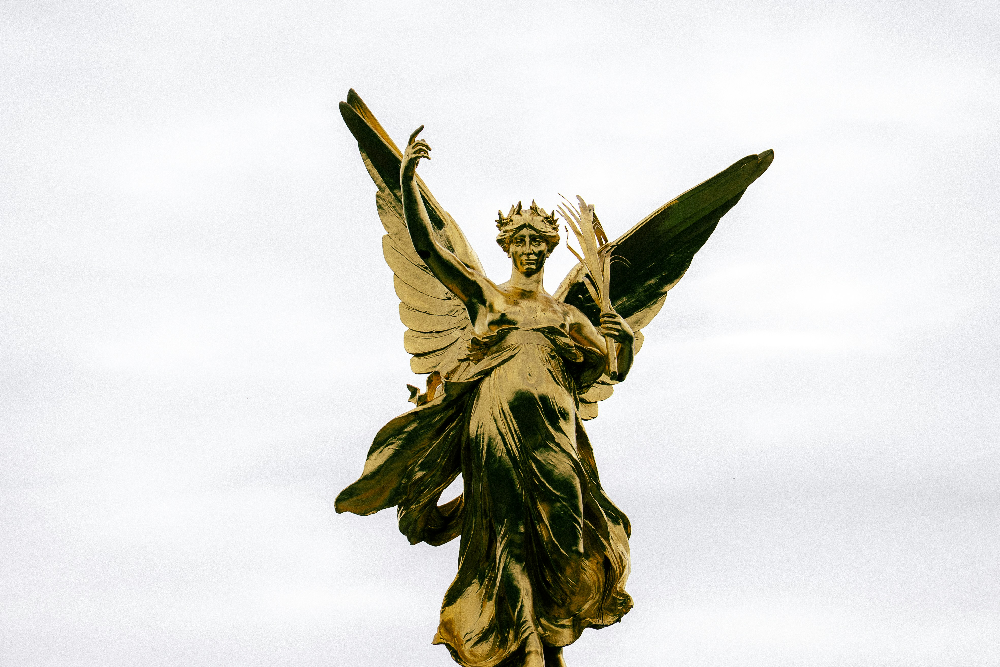 Golden Angel Overlook: Winged Statue Reaching into the Sky