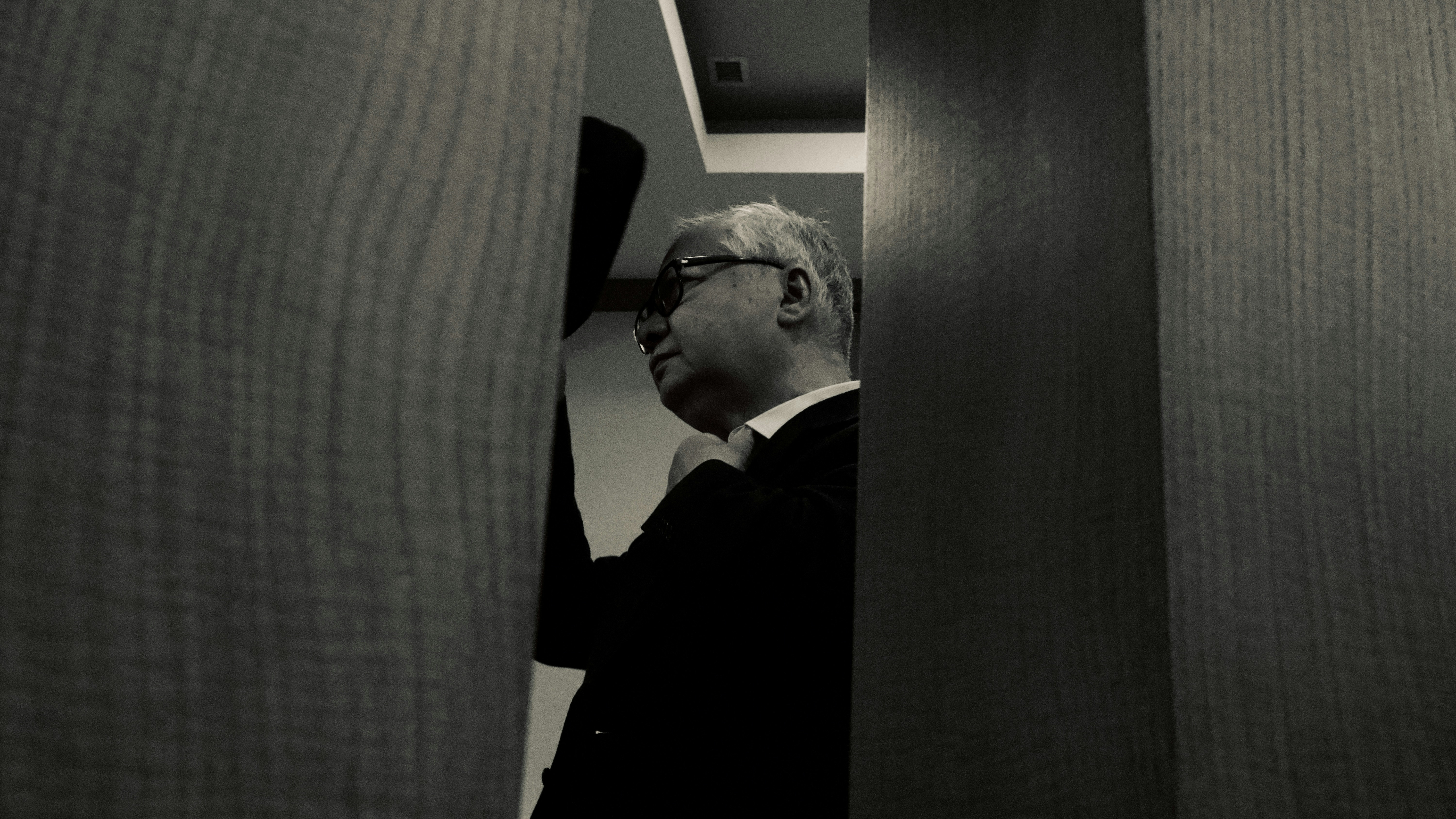 Between Walls: A Quiet Portrait of a Man in a Suit