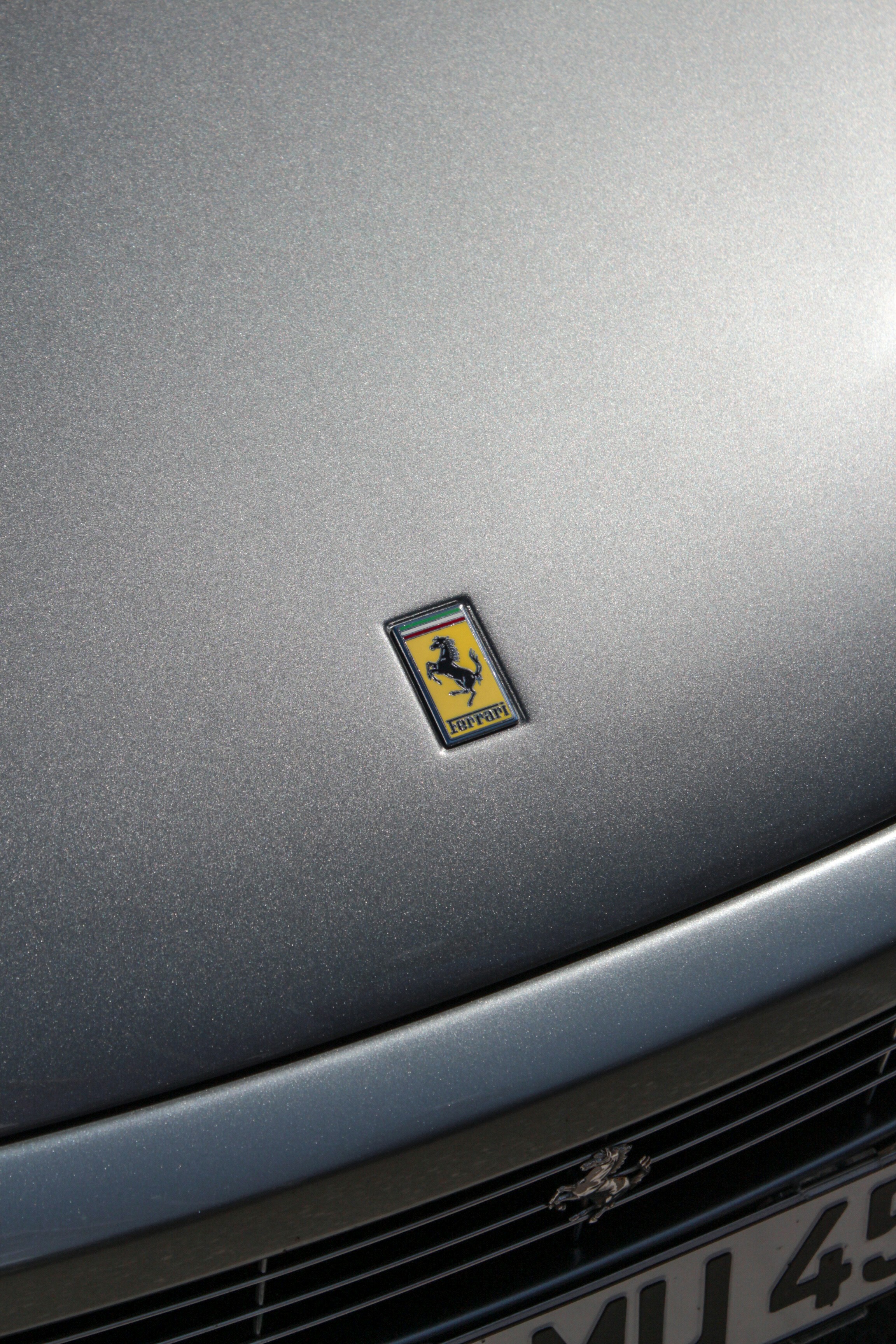 Ferrari Emblem on Metallic Hood: Subtle Shine and Brand Detail