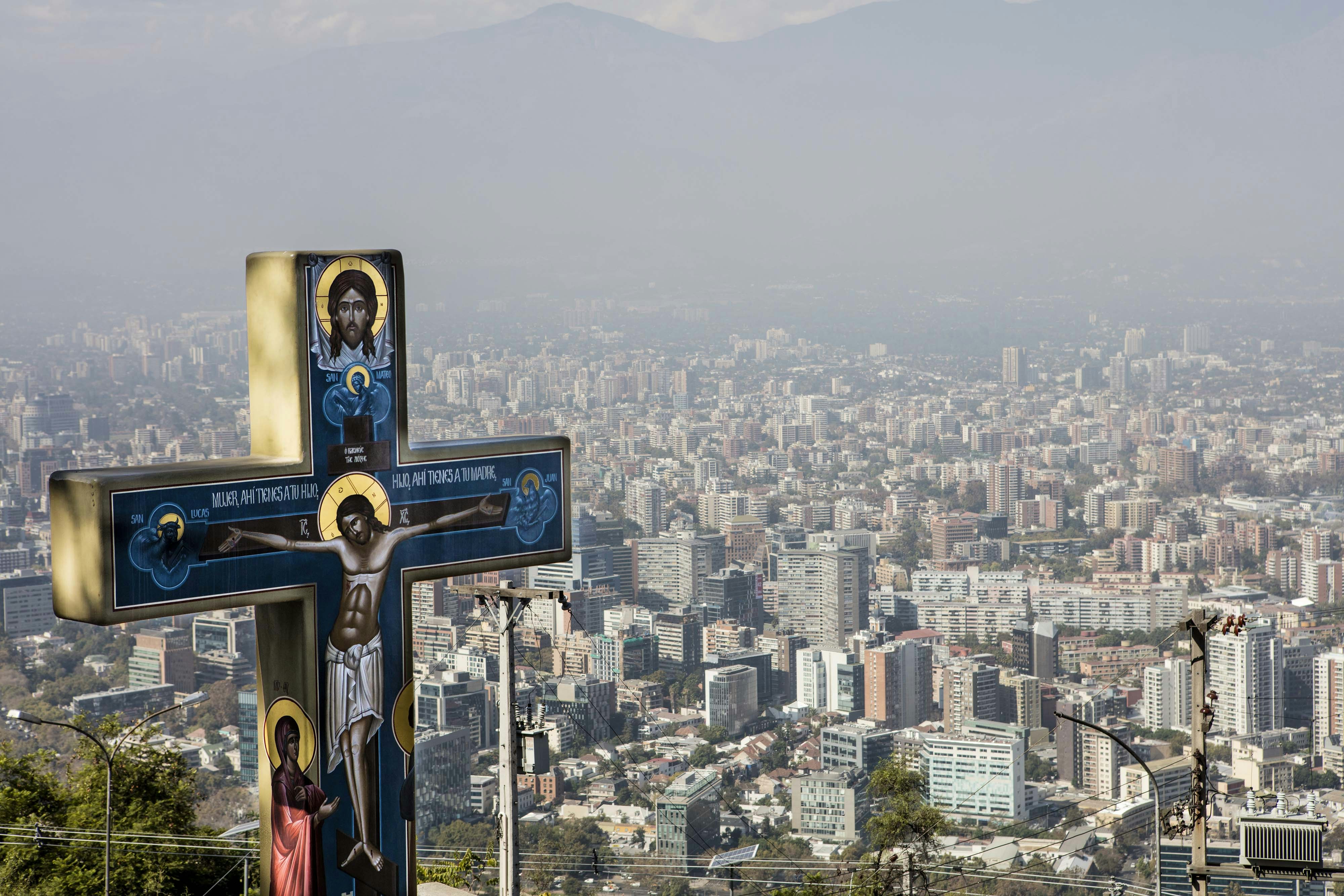Overlooking Faith: A Sacred Cross Framing a Cityscape