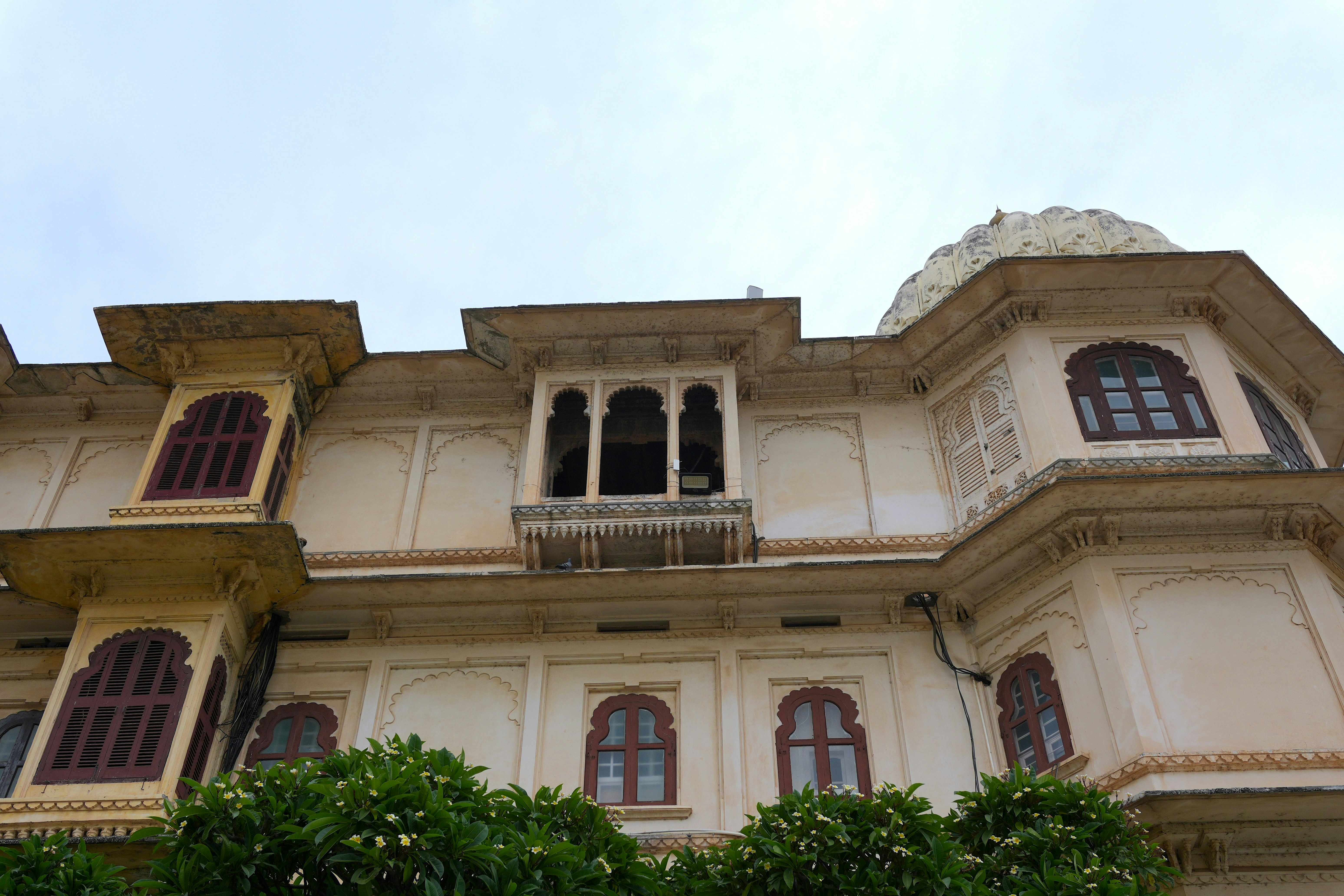 Ornate Balcony Gable: A Heritage Facade Rising Under Open Sky