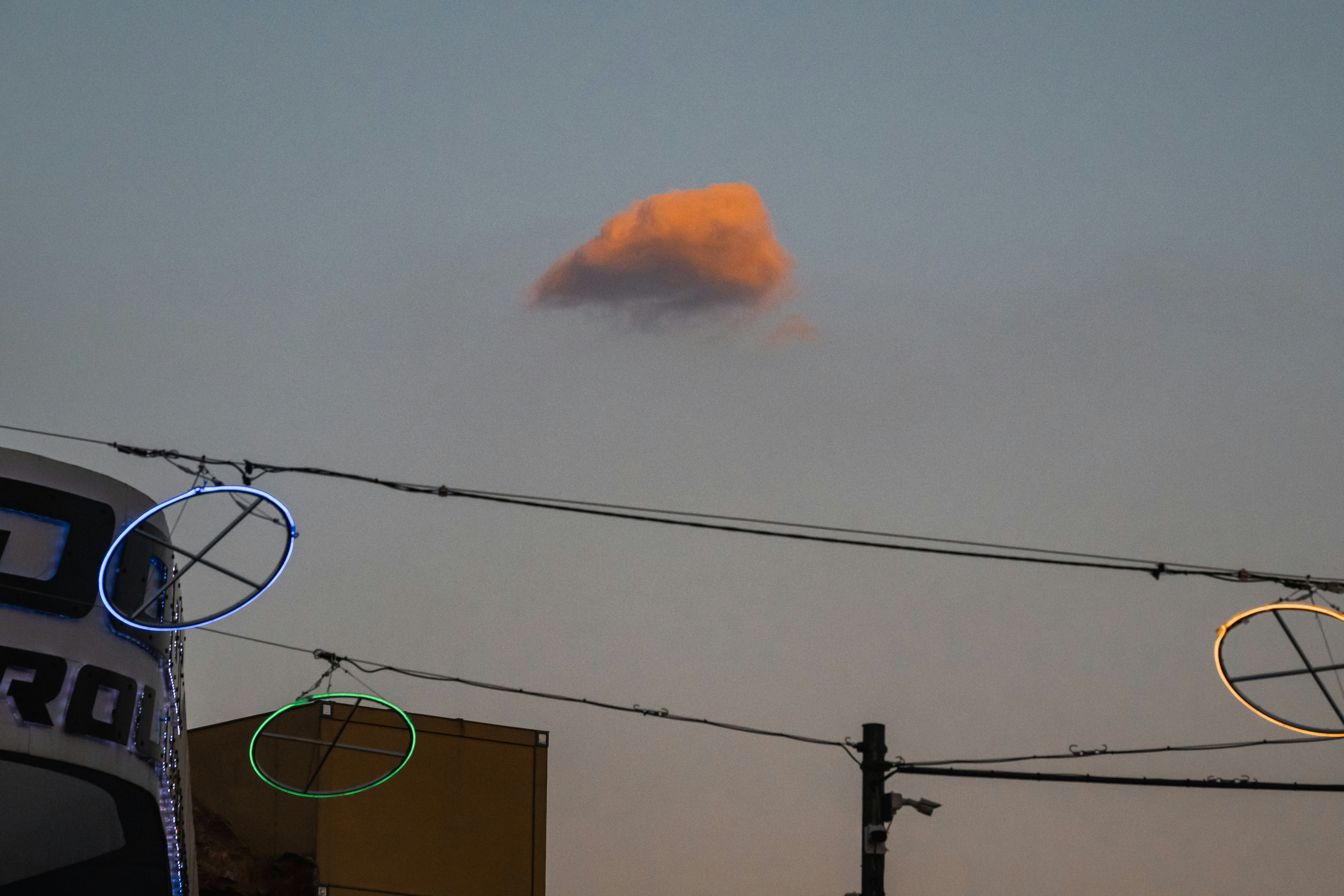 Orange Cloud over a Street Scene with Neon Recircular Lamps