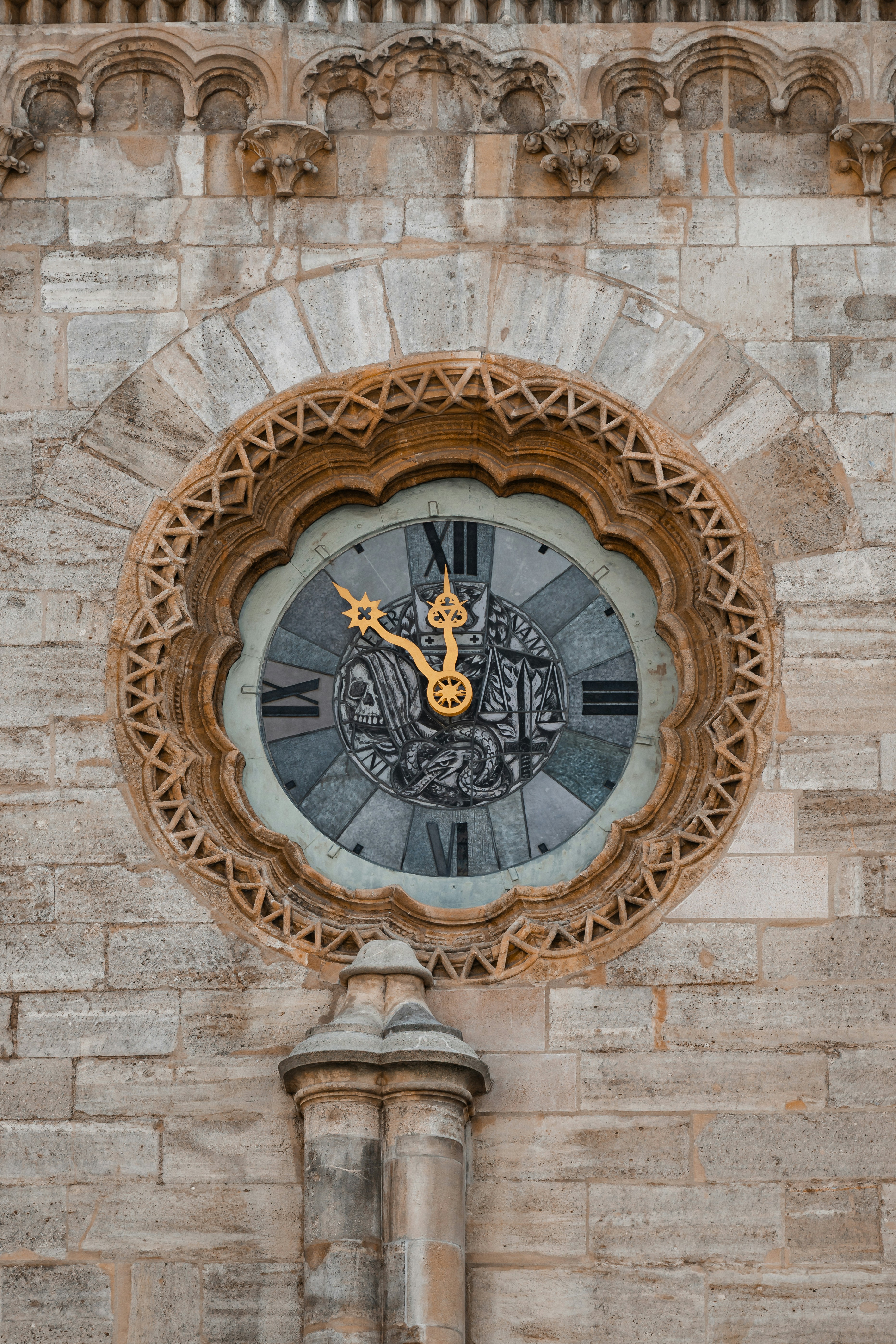 Ancient Clockwork Gate: Ornate Circular Dial Embedded in Stone Facade