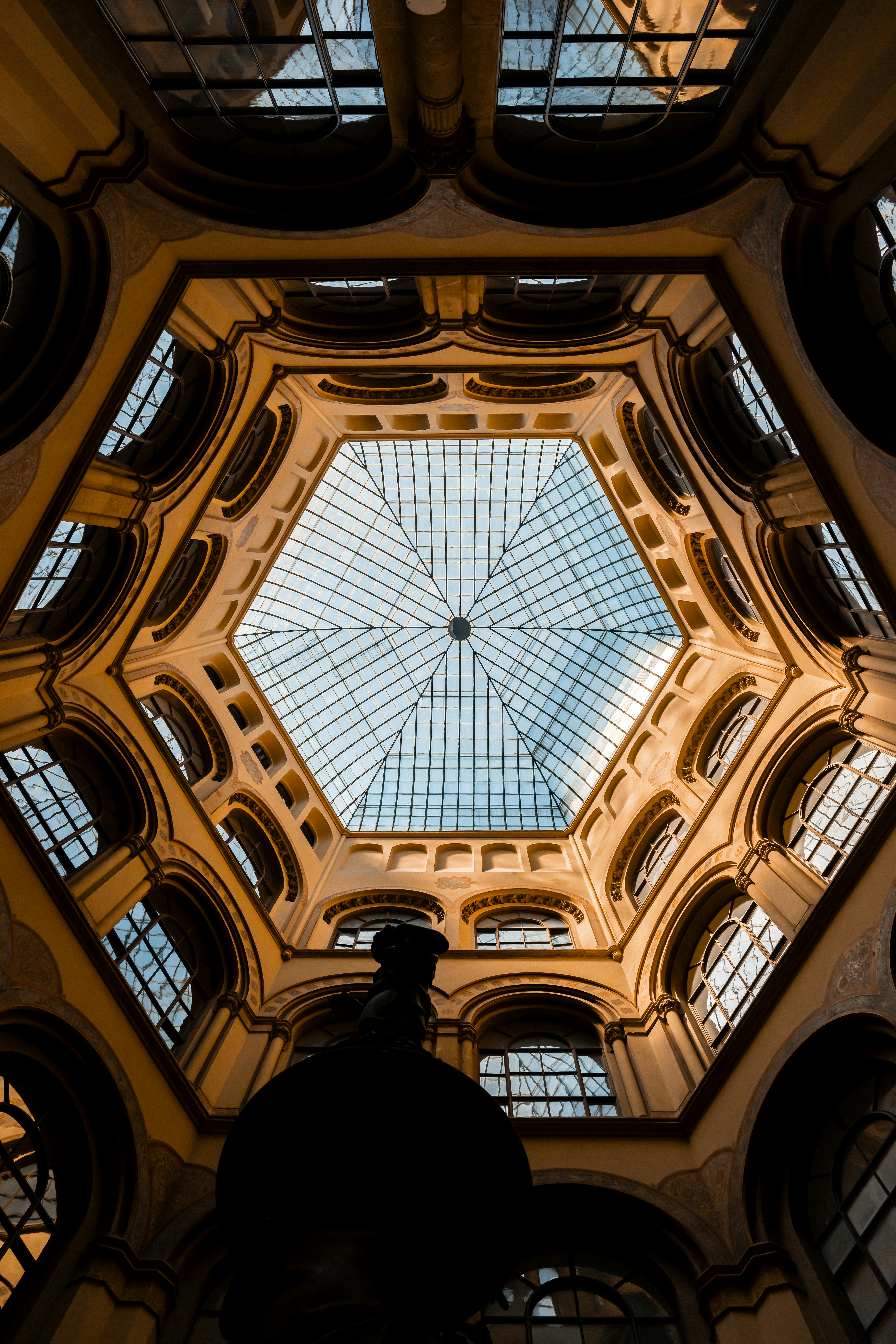 Apex Atrium: Vaulted Glass and Golden Arches