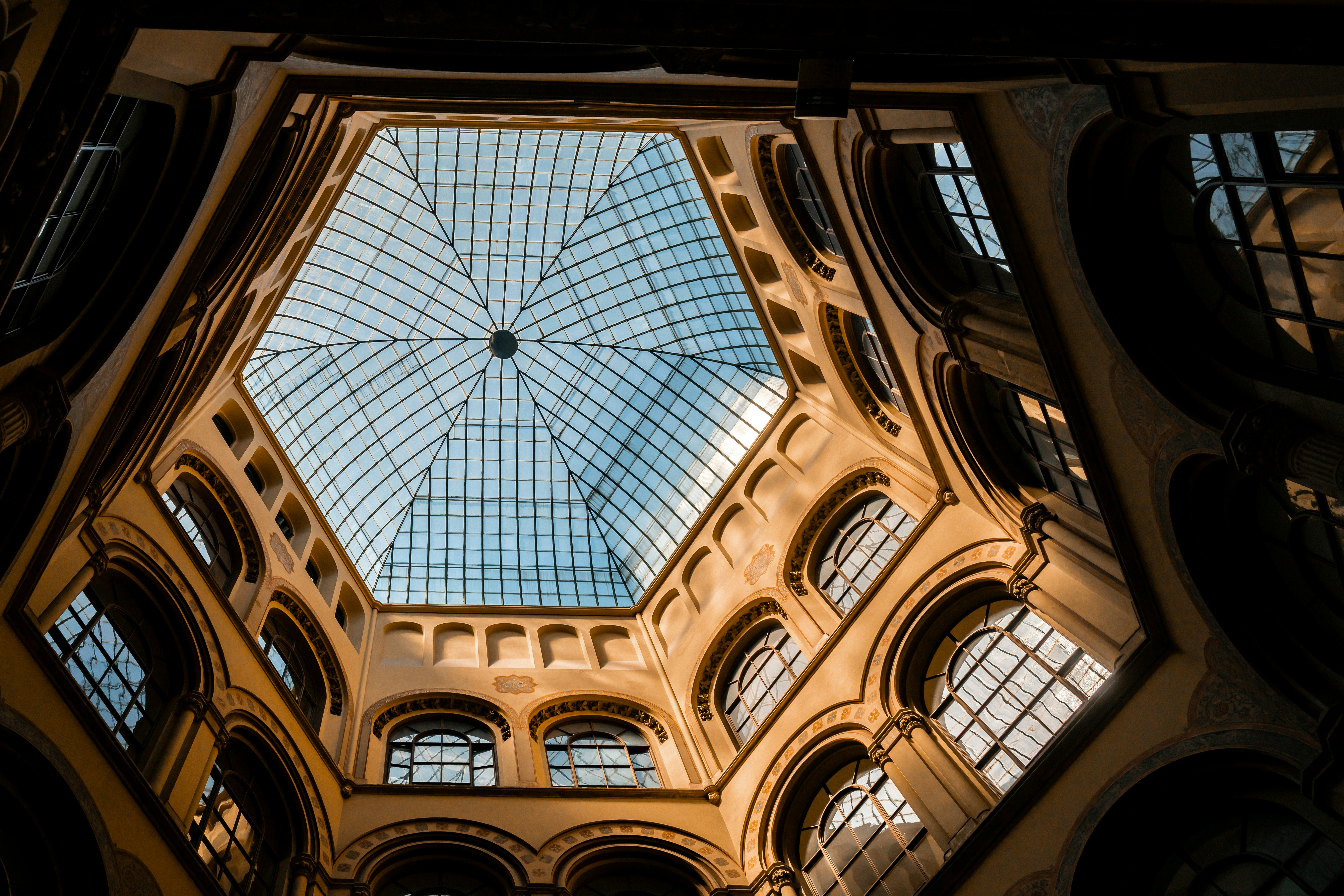  skylight under glass petals: a grand atrium’s glass dome framing