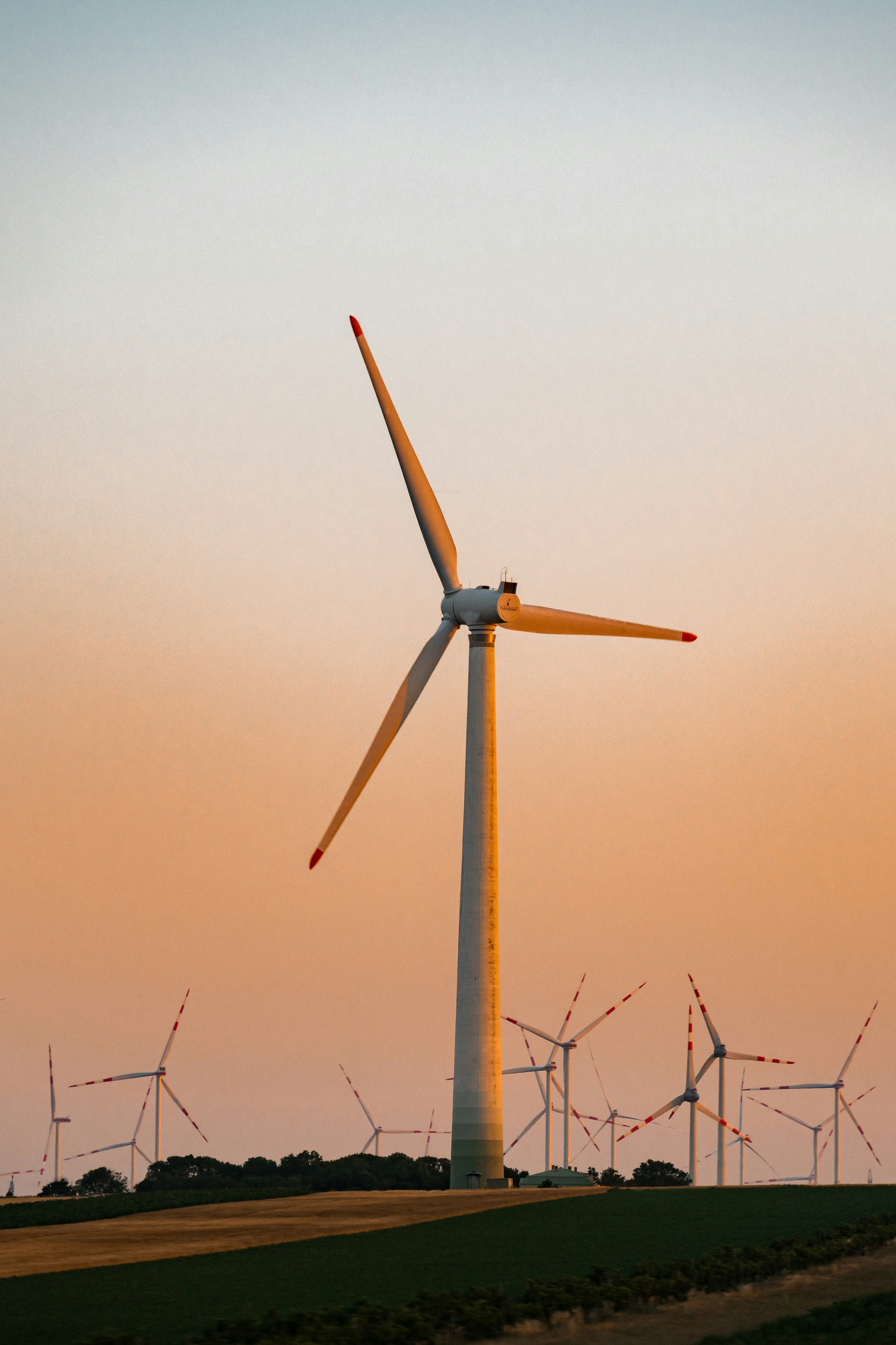 Harvesting the Wind: A Wind Turbine Illuminated at Sunset