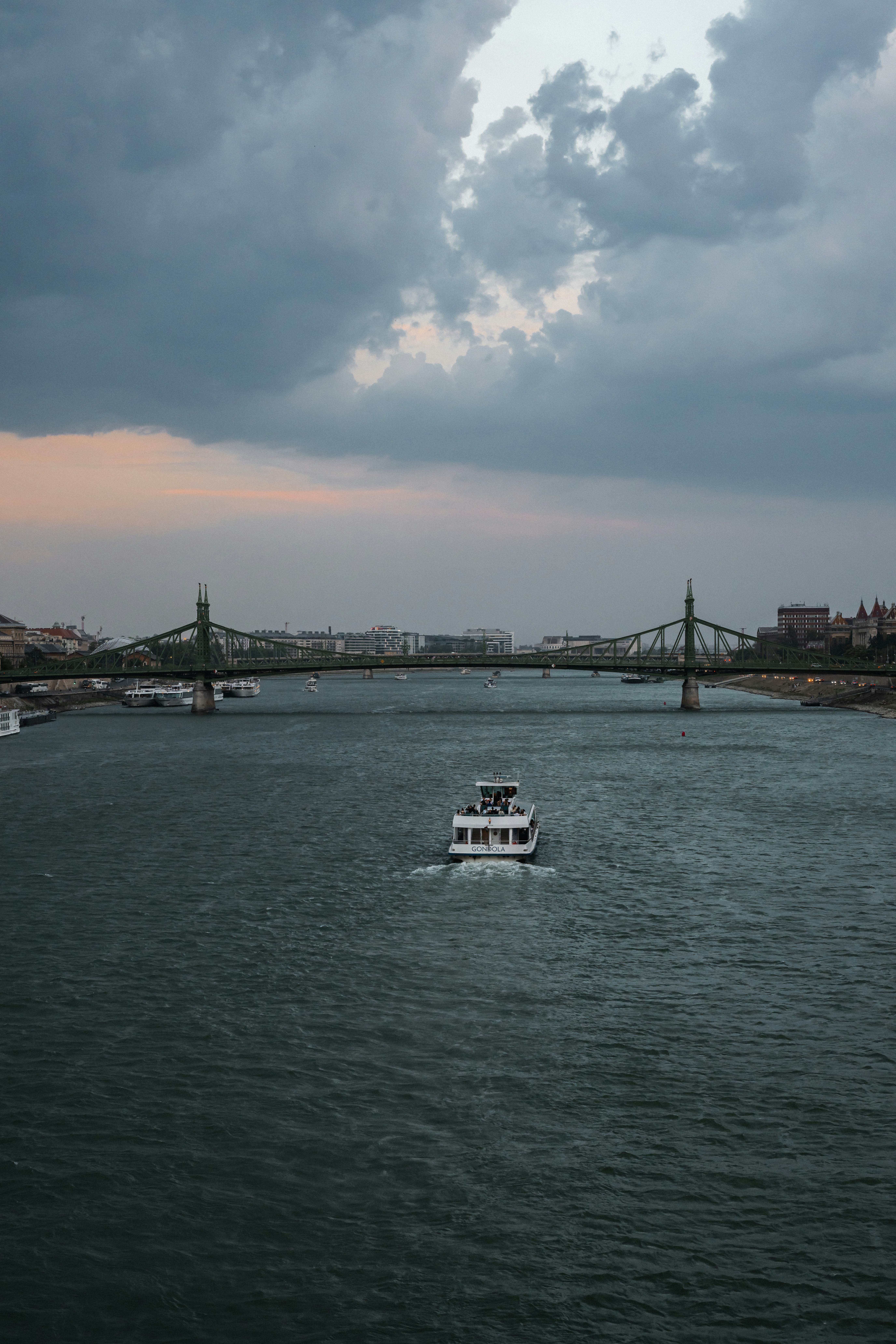 Toward the Quiet City Sky: Boat Beneath a Museum-Row Bridge