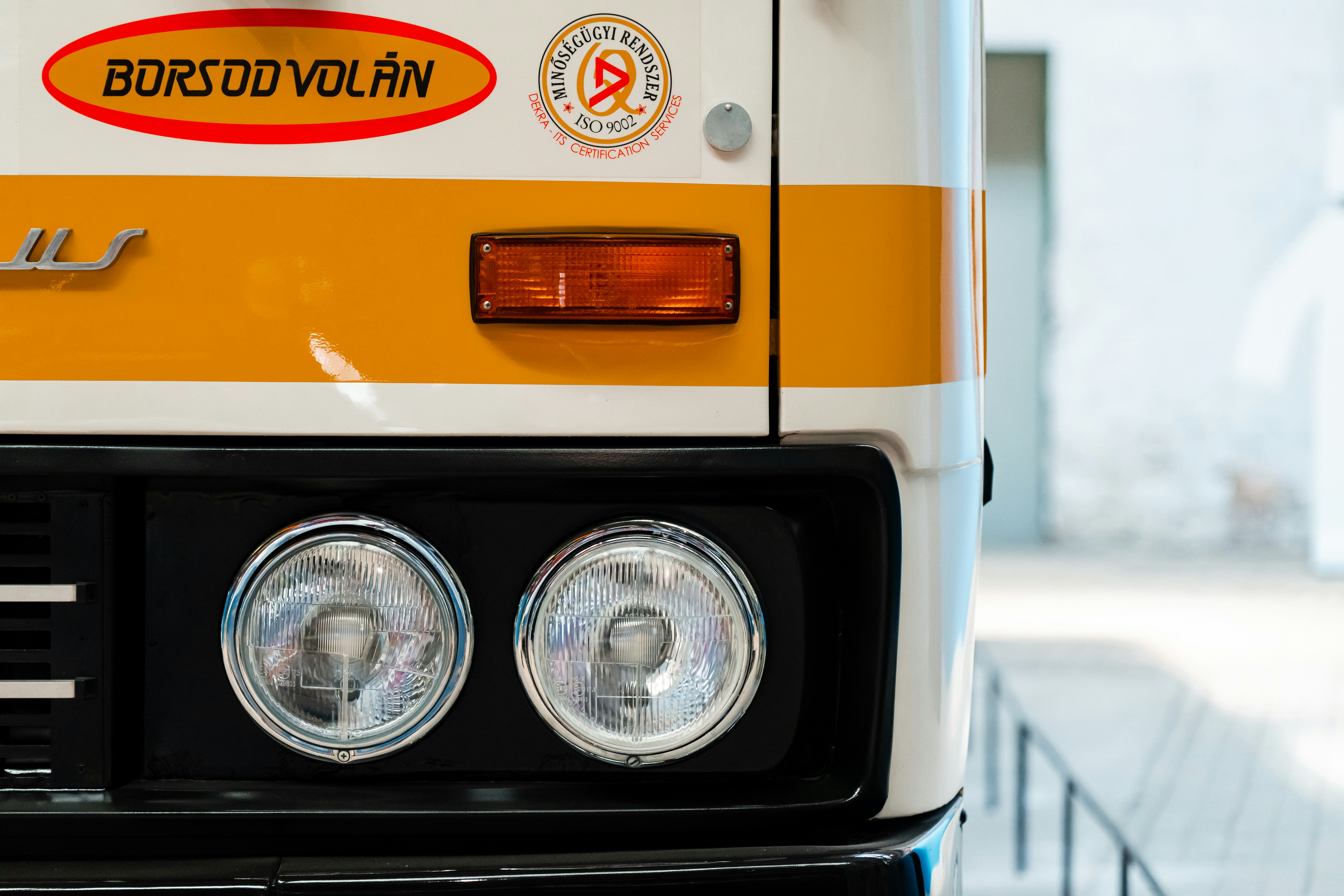 Frontline Detail: The Orange-White Bus with Round Headlights