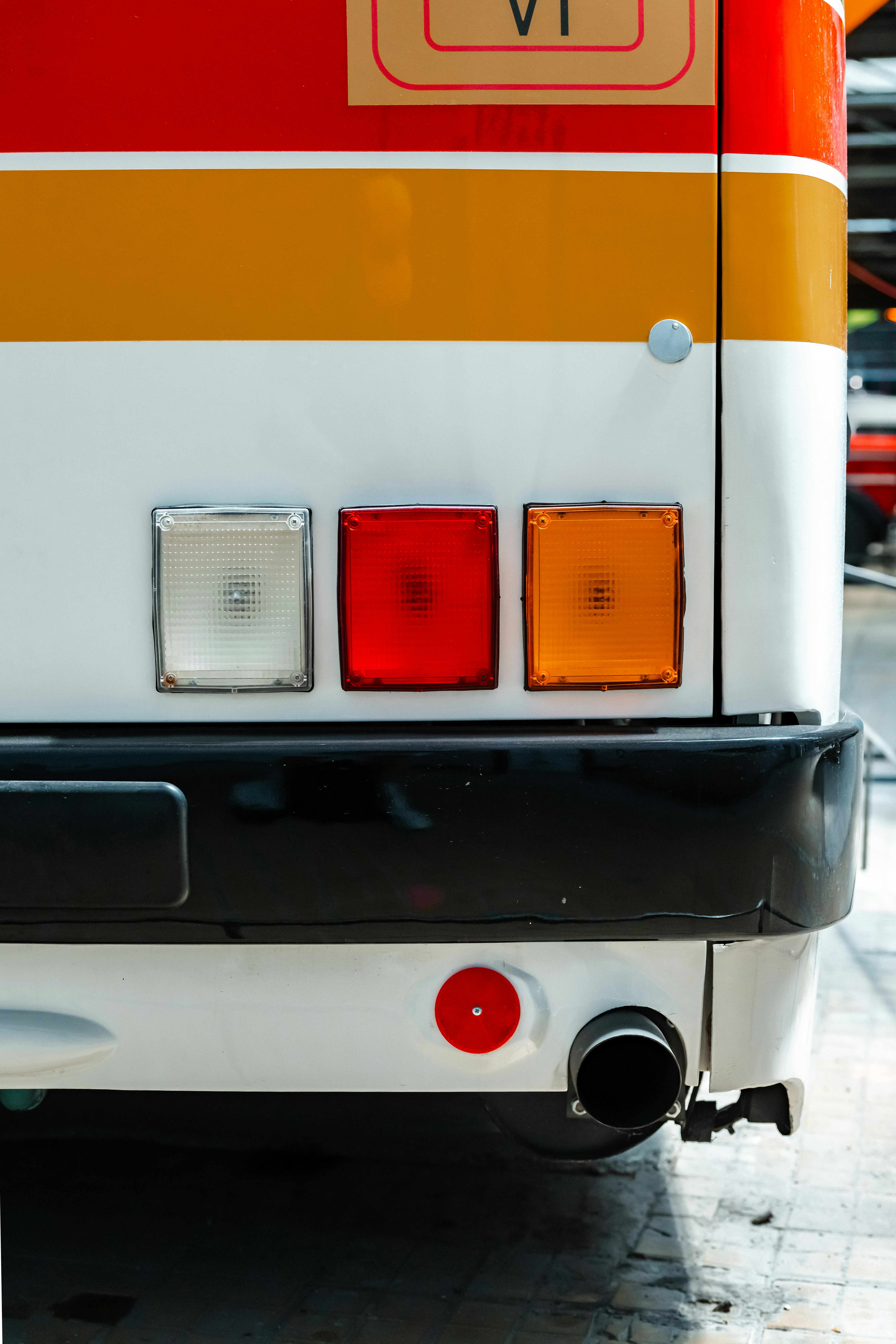 Rearview Portrait of a Transit Vehicle: Tail Lights and Exhaust Details
