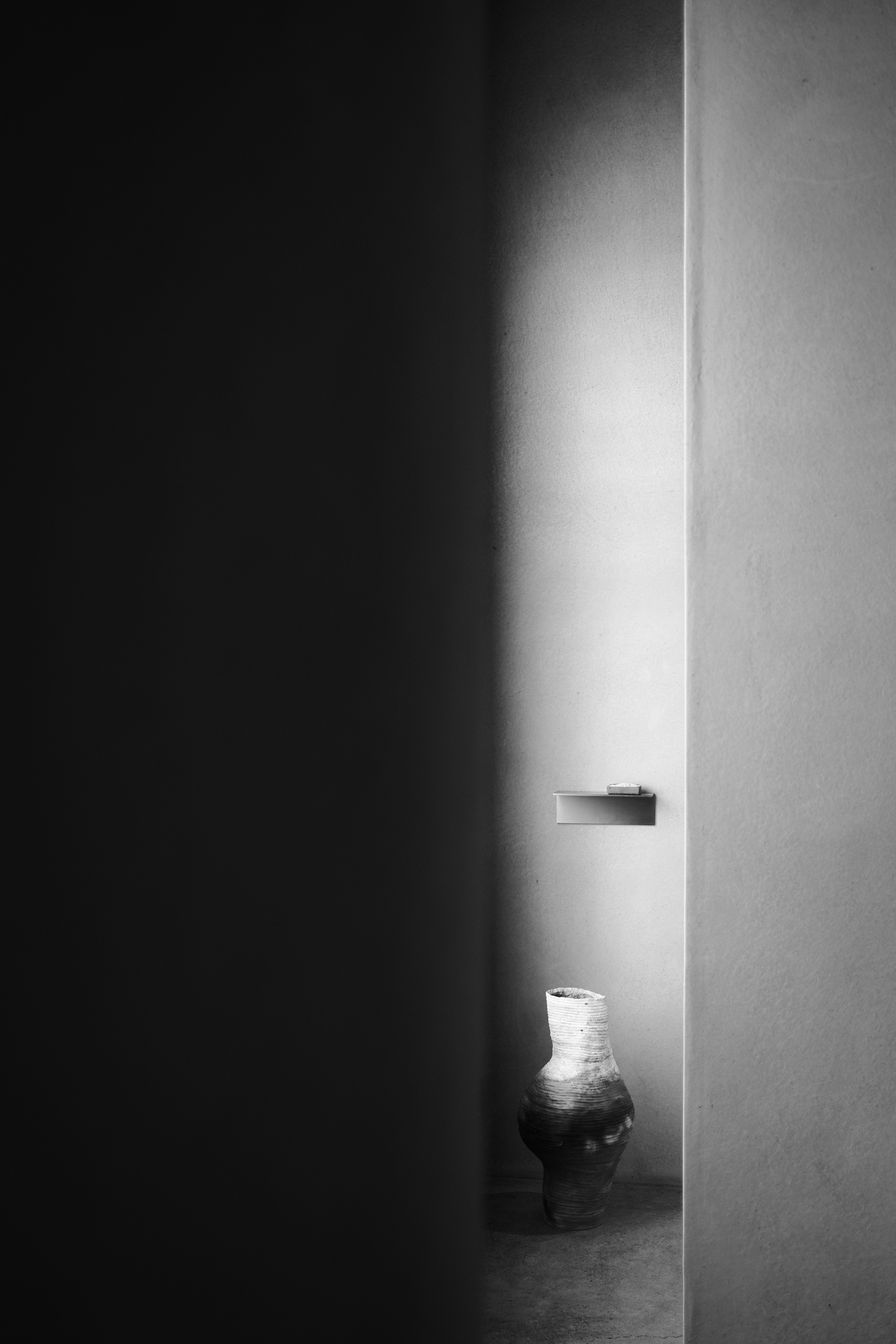 Between Shadow and Light: A Minimal Still Life Through a Doorway