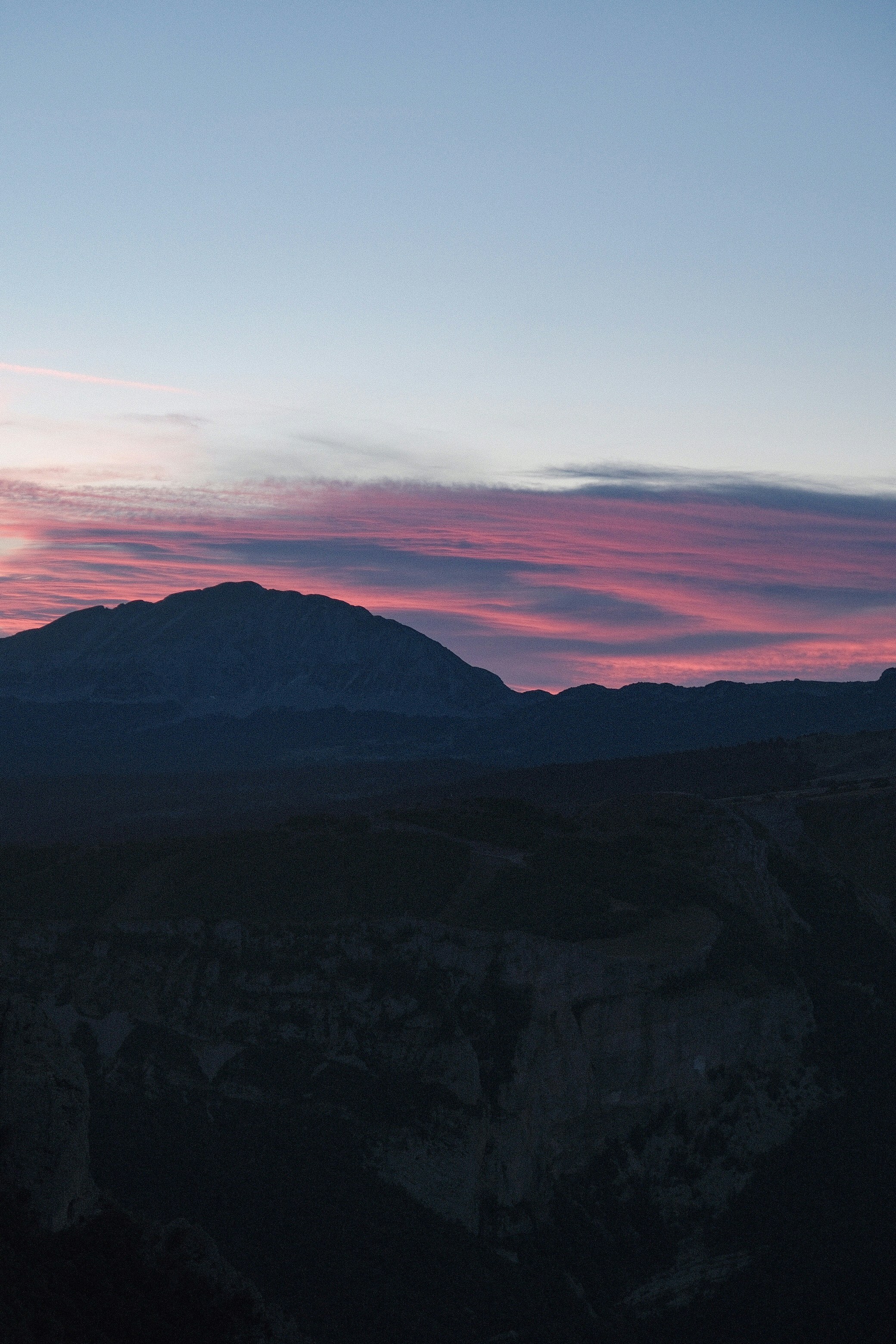 Twilight Crest: A Distant Ridge Bathed in Pink and Indigo