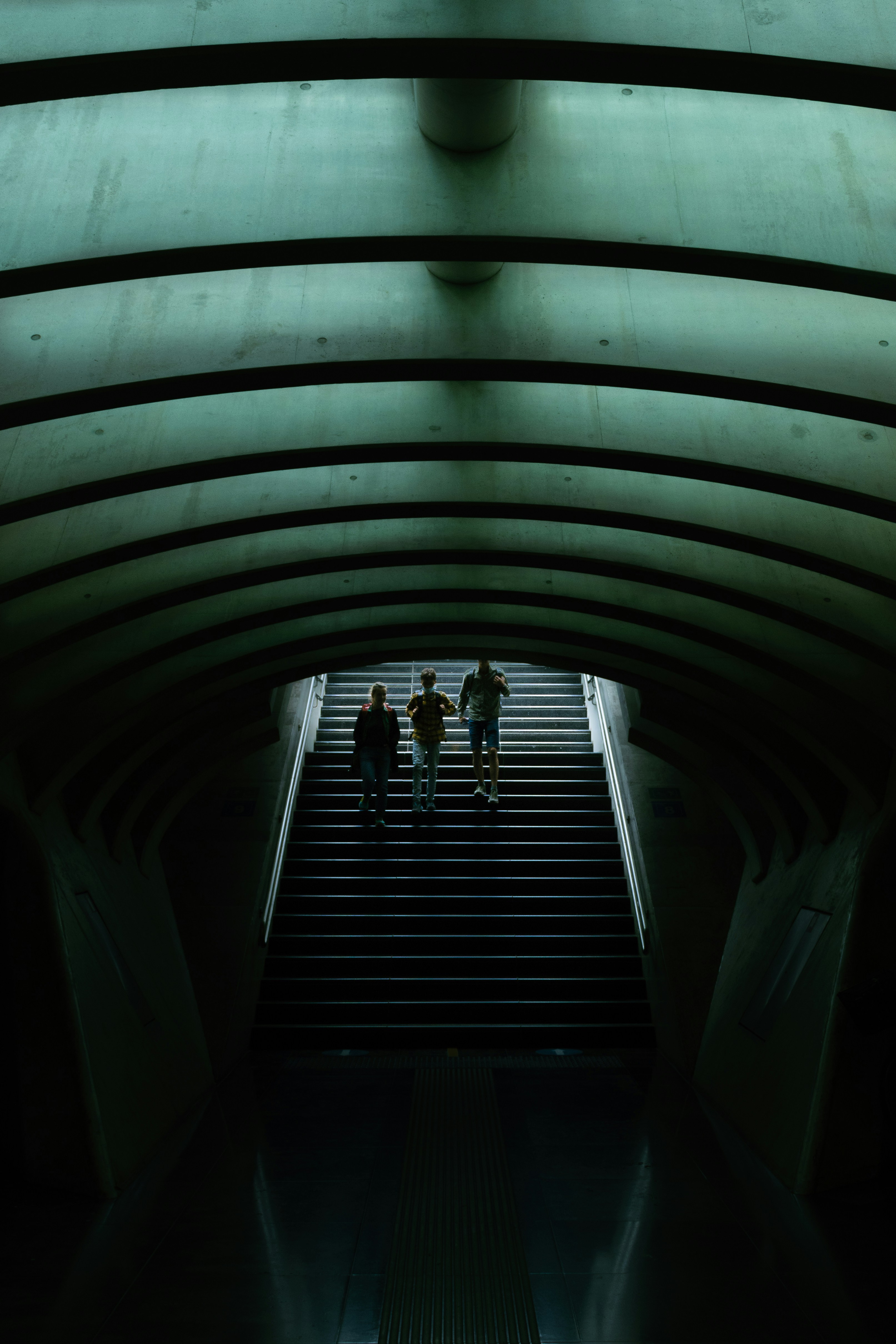 Emergence at the Arch: Riders of Light Descend the Stairs