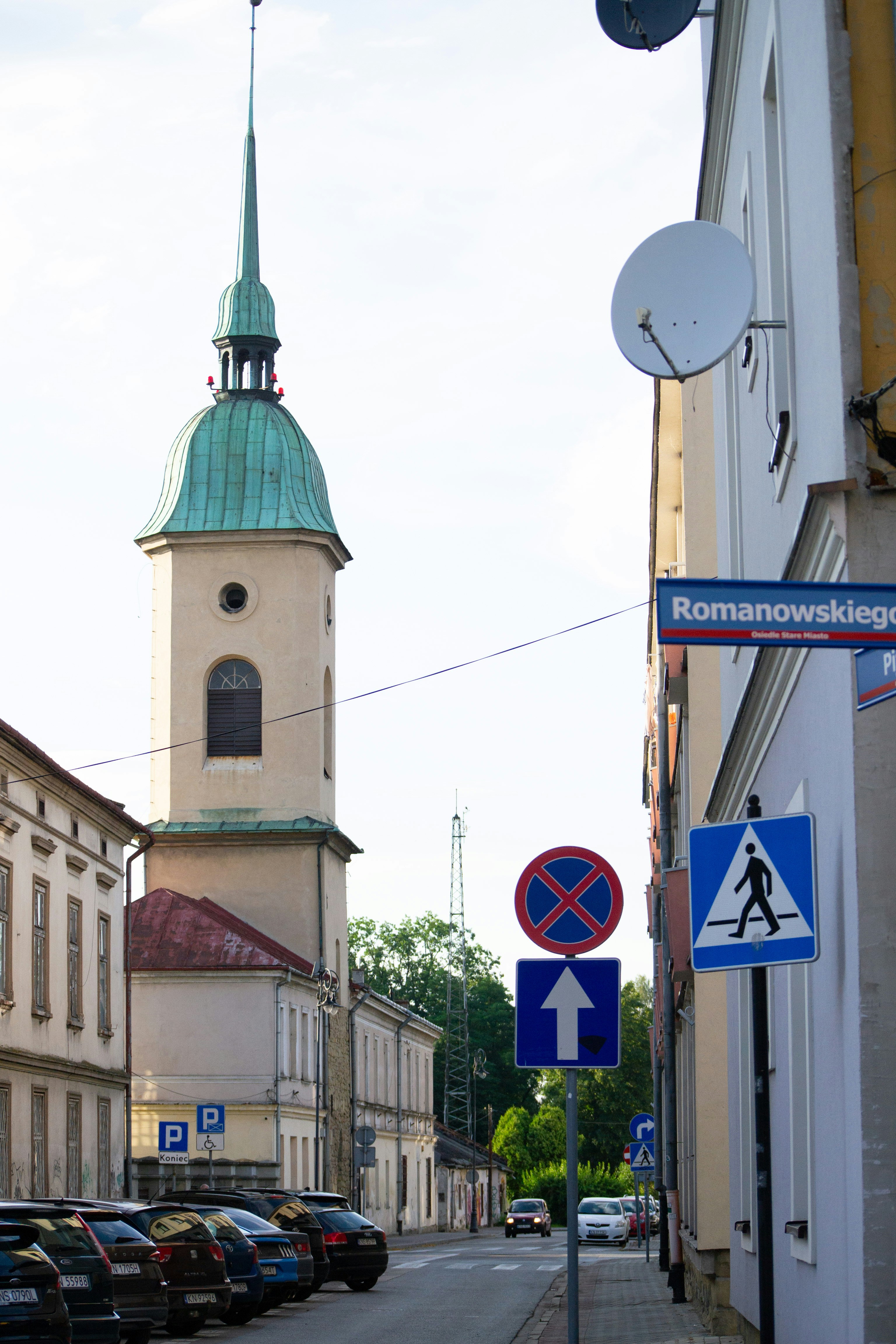 Street Clock Tower and Blue Street Sign on Romanowskiego Corner